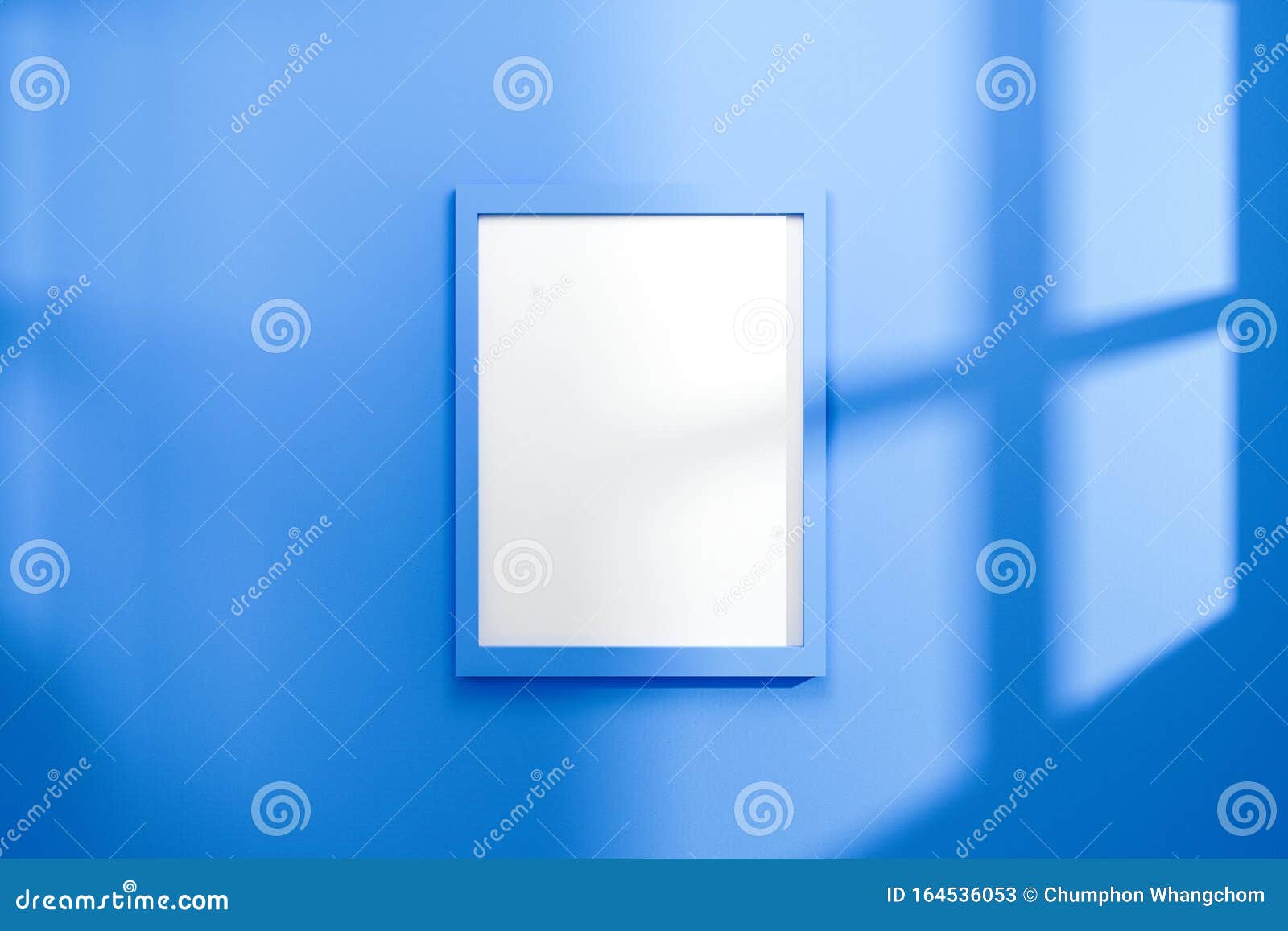 Empty Frame on Vivid Blue Wall Background with Natural Light of Window ...