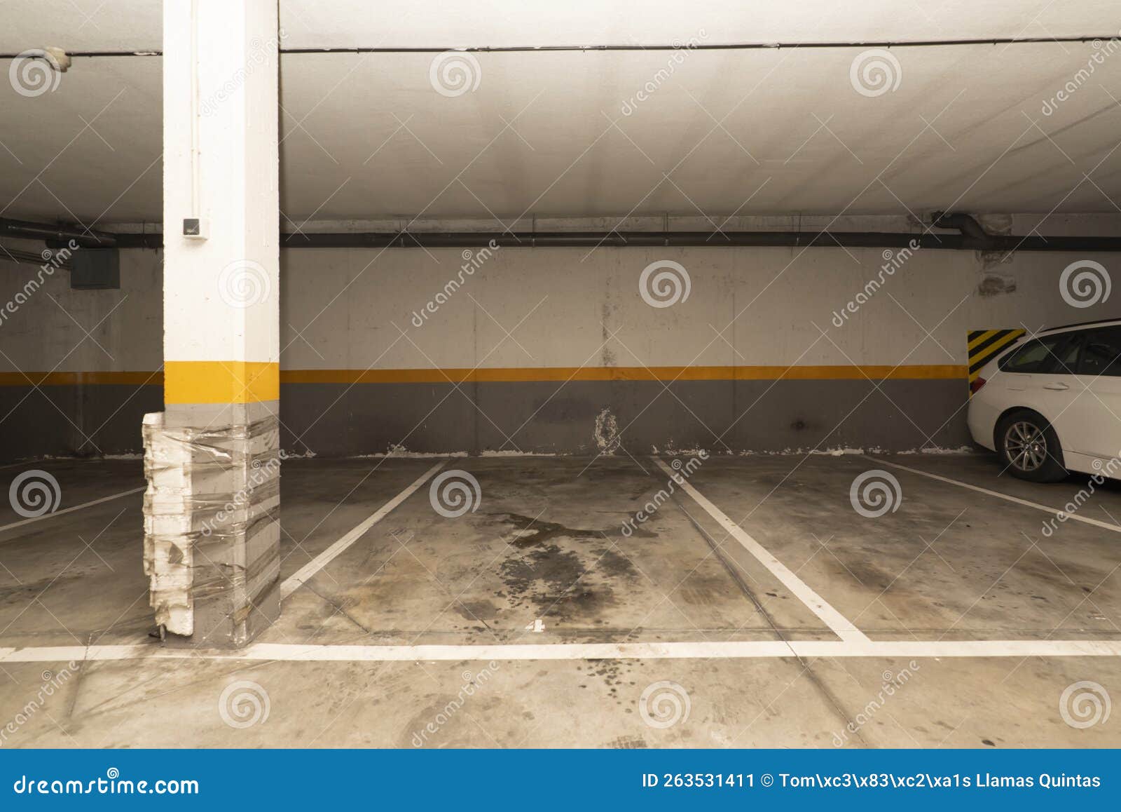 An Empty Garage Space with the Edges Painted White Stock Image - Image ...