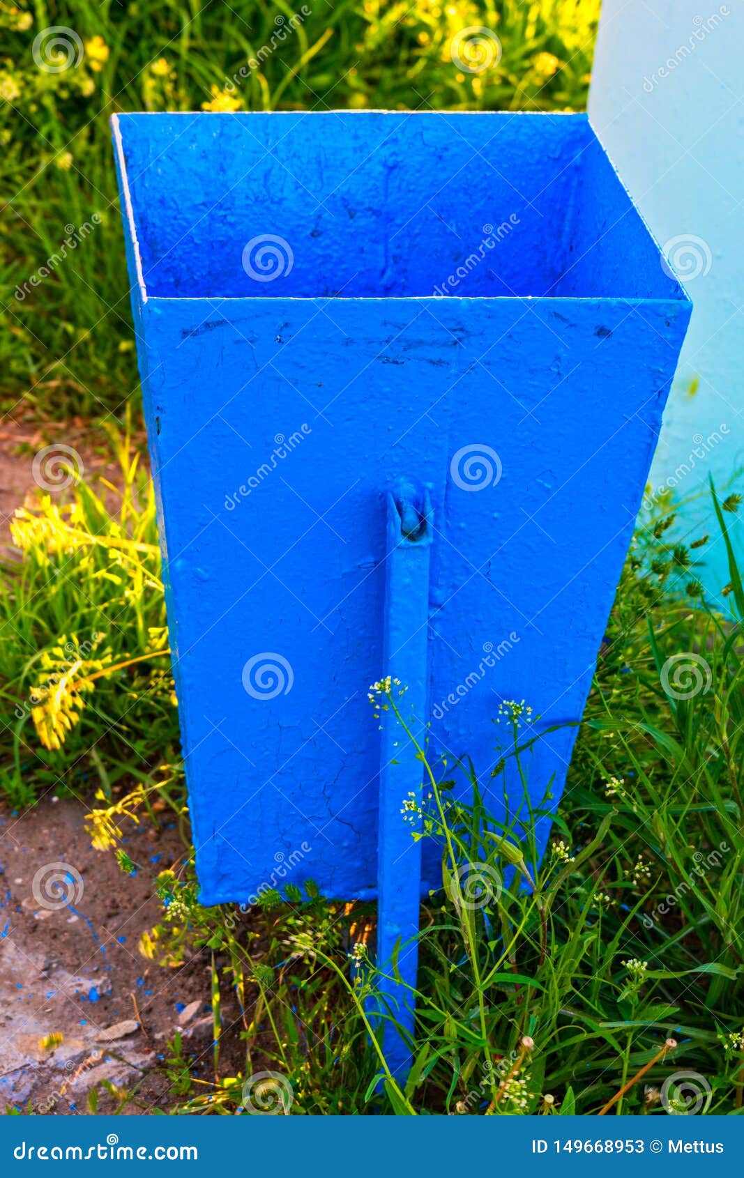 Empty Garbage Bin Painted in Bright Blue Color in the Garden Stock ...
