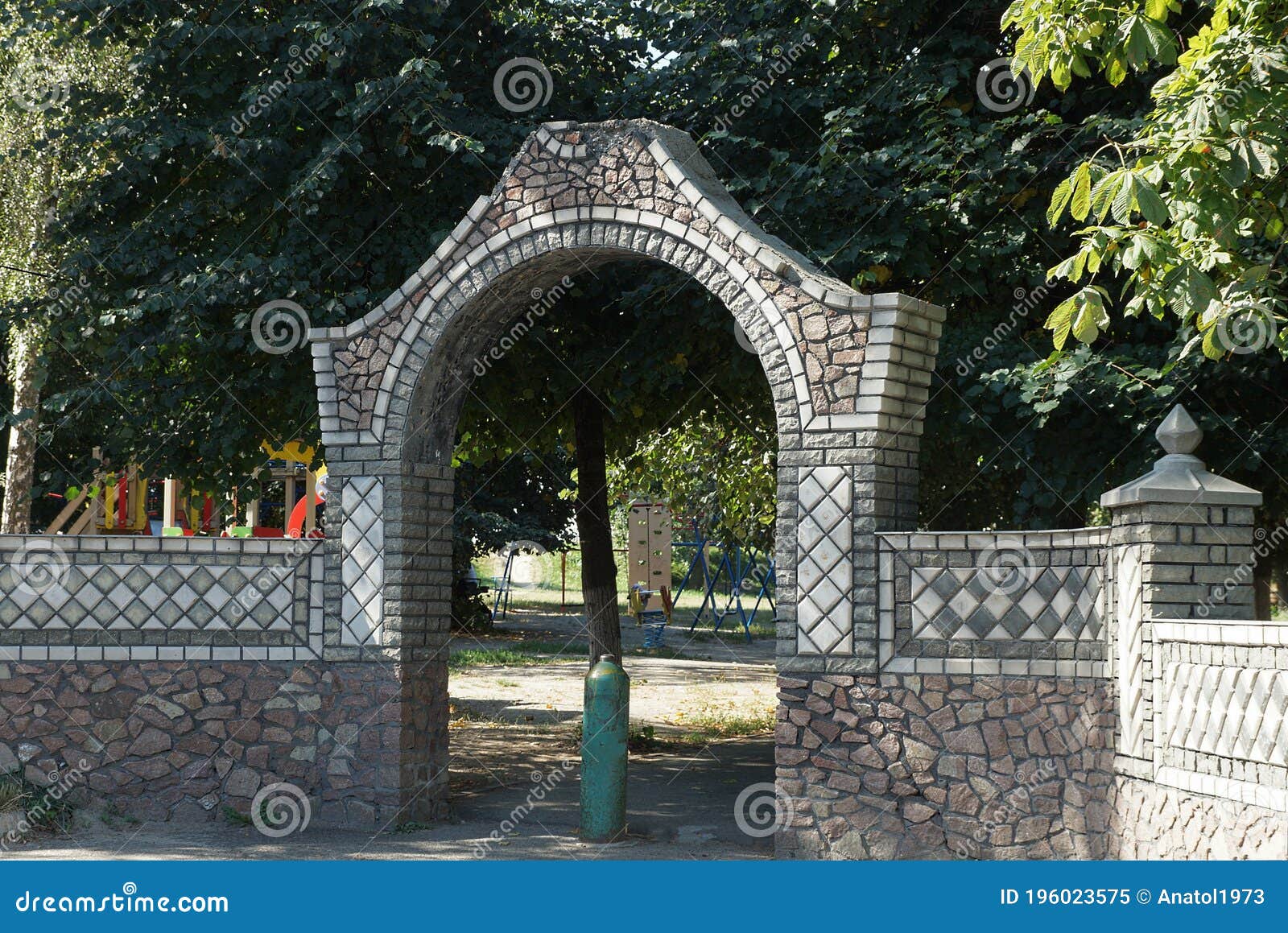Empty Gate Arch Made of Gray Stone and Bricks and Part of the Fence ...