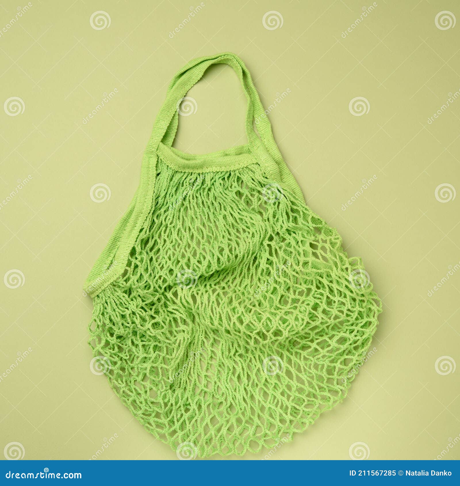 Empty Green Reusable String Bag Woven from Thread on a Green Background ...