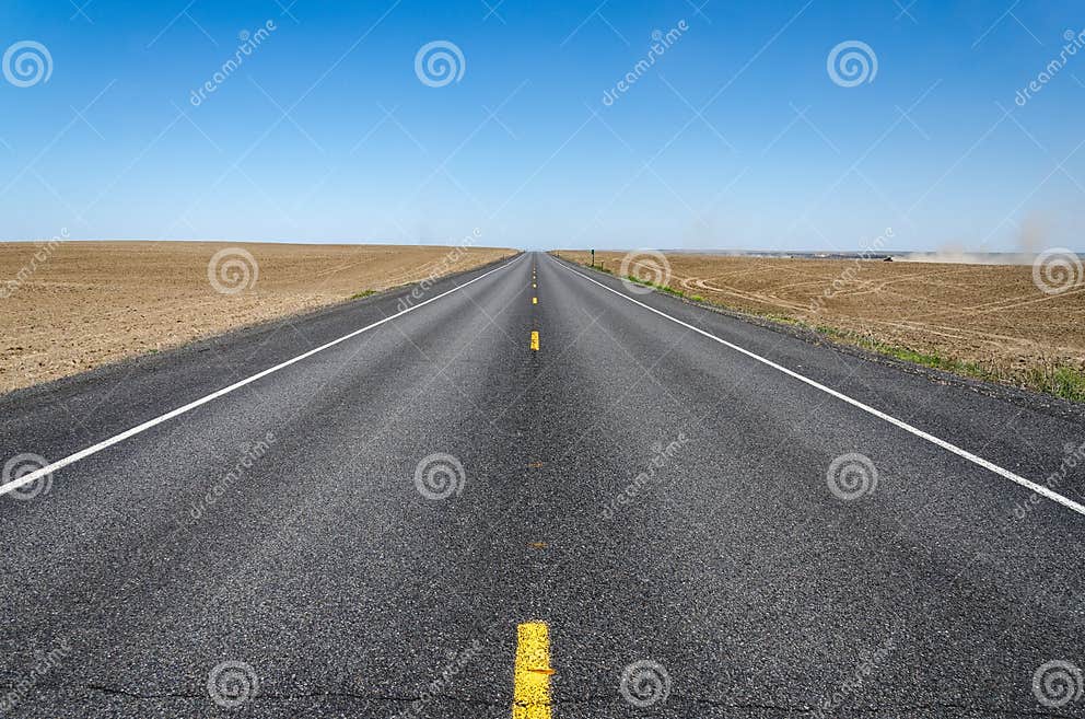 Empty Highway with a Farm Tractor in the Fields Stock Photo - Image of ...