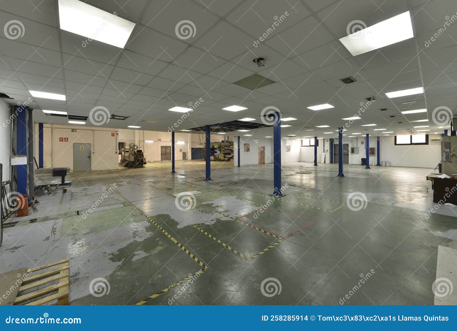Empty Industrial Warehouse with Blue Metal Columns and Technical ...