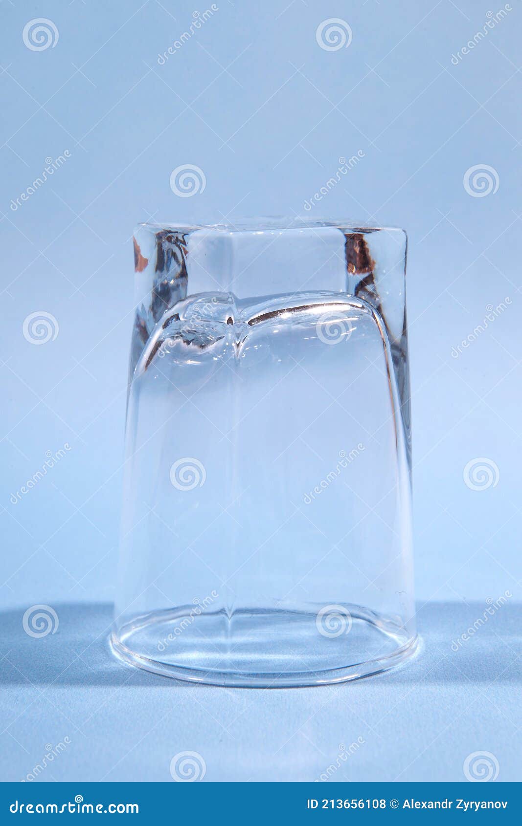 Empty Inverted Glass on Blue Background. Studio Photo Stock Photo ...