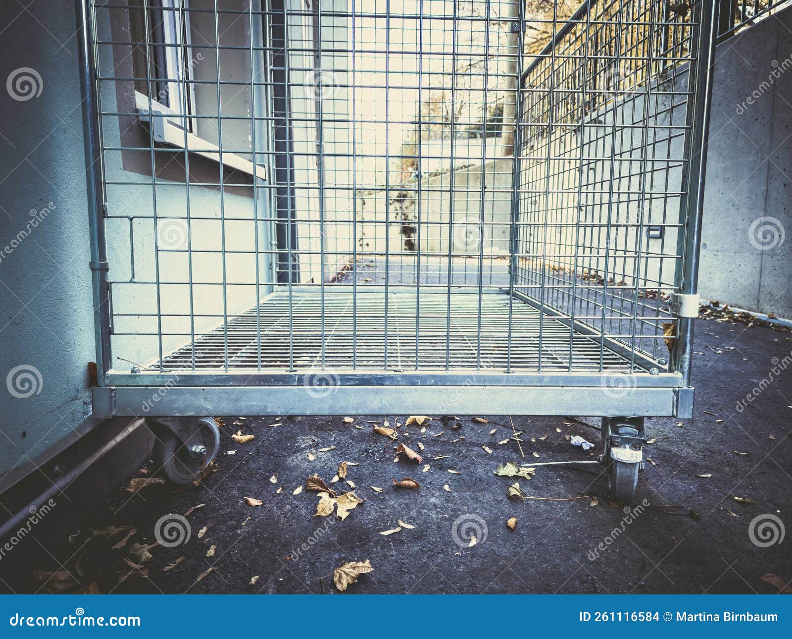 Empty Iron-barred Box on Wheels Outside a Buidling Stock Photo - Image ...