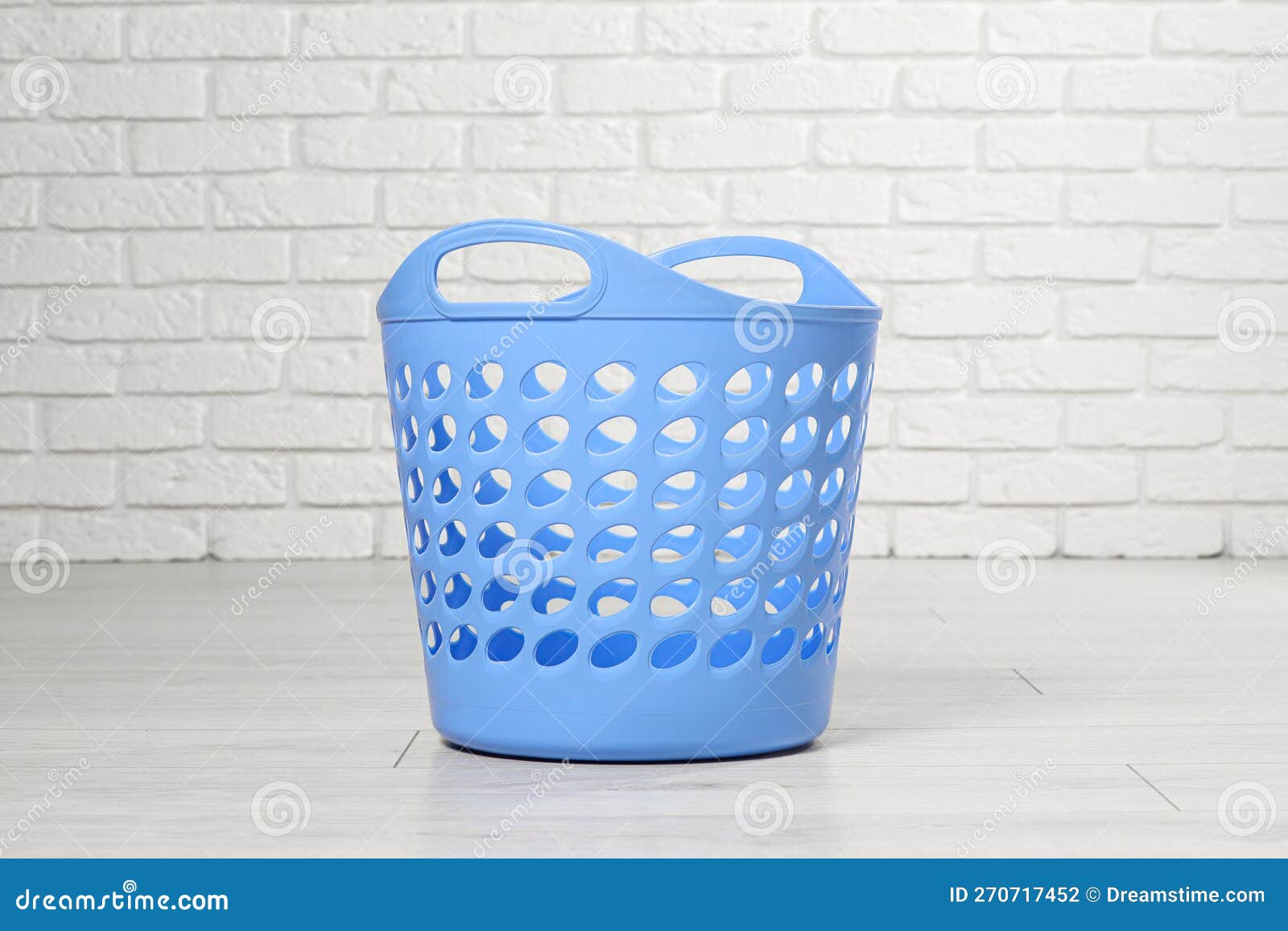 Empty Laundry Basket Near White Brick Wall Stock Photo - Image of ...