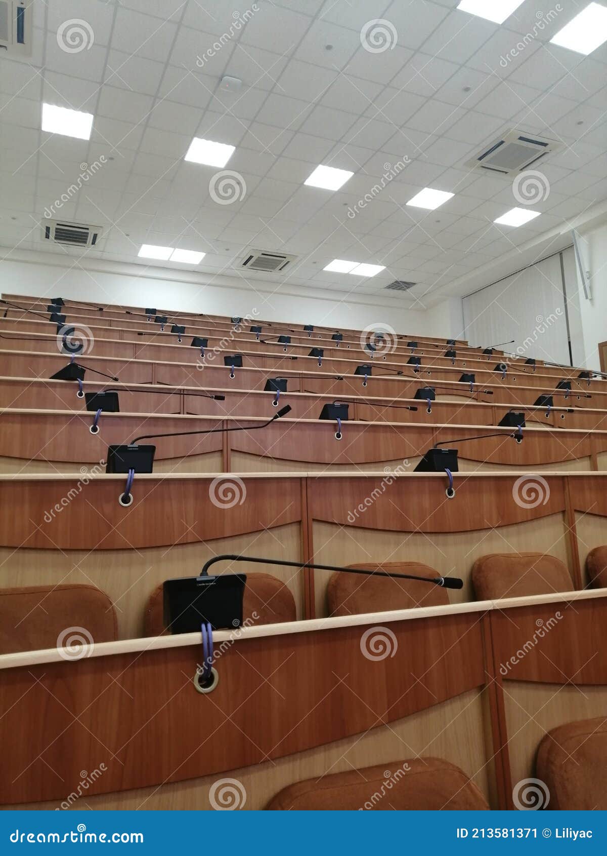 Lit Classroom With Rows Of Wooden Tables For Royalty-Free Stock ...