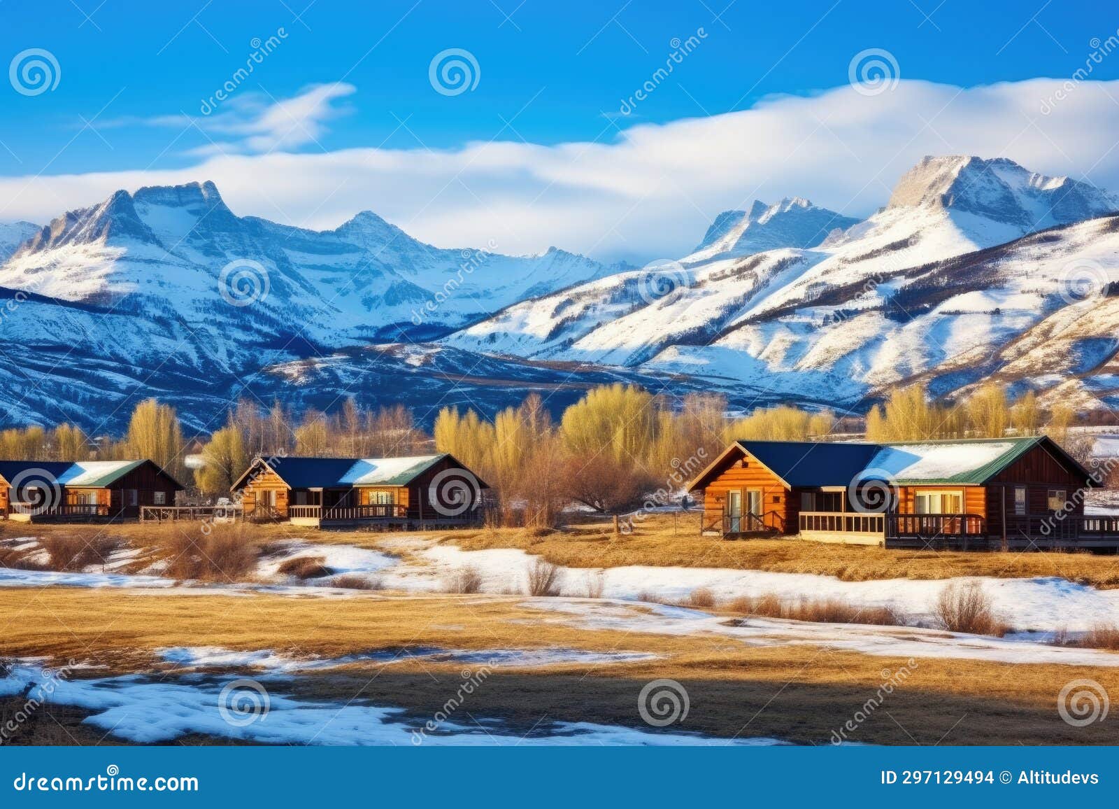 Empty Log Cabins Lined Up Against Snowy Mountains Stock Photo - Image ...
