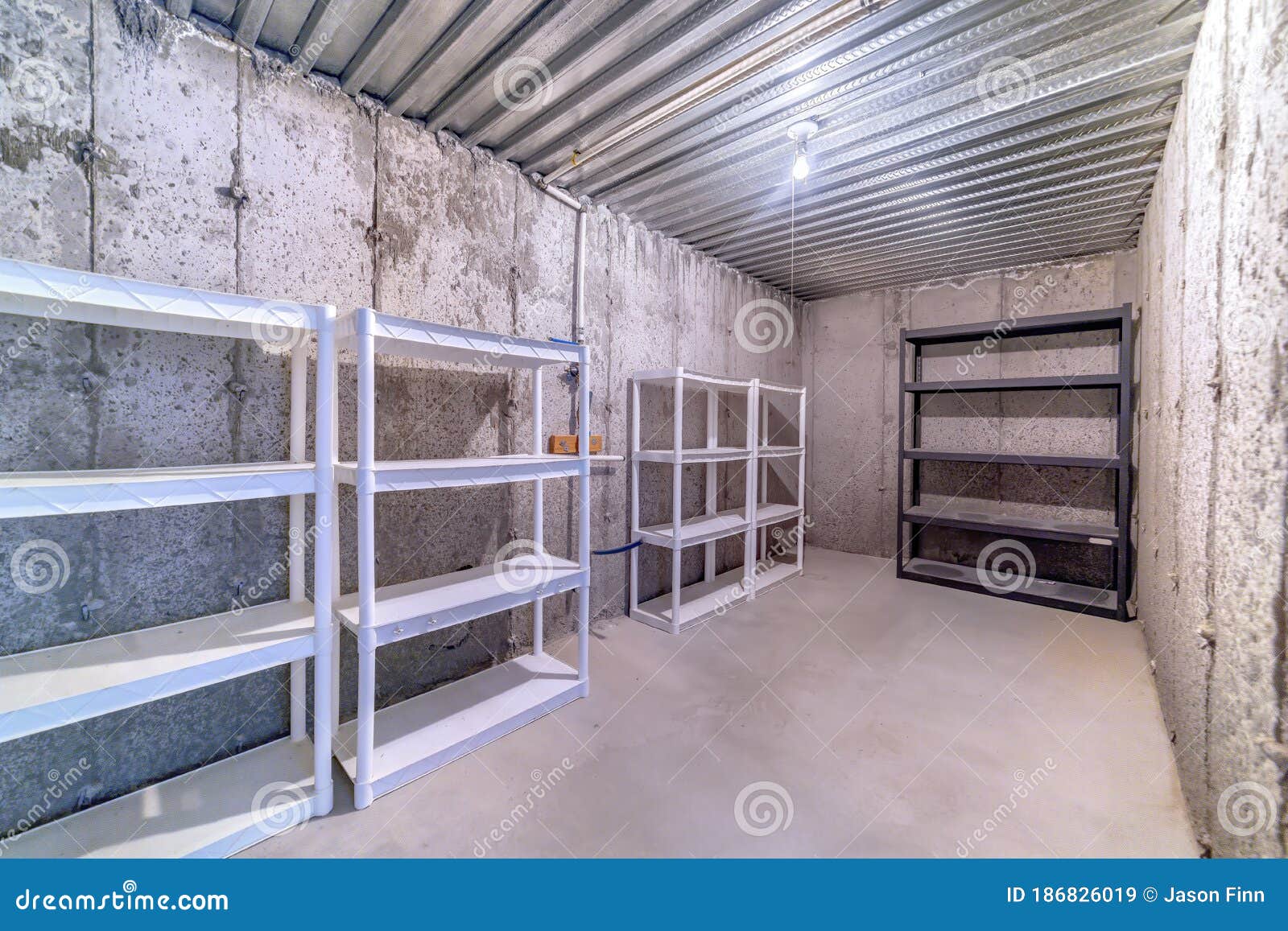 Empty Multi Layer Metal Racks Inside a Storage Room with Concrete Wall ...