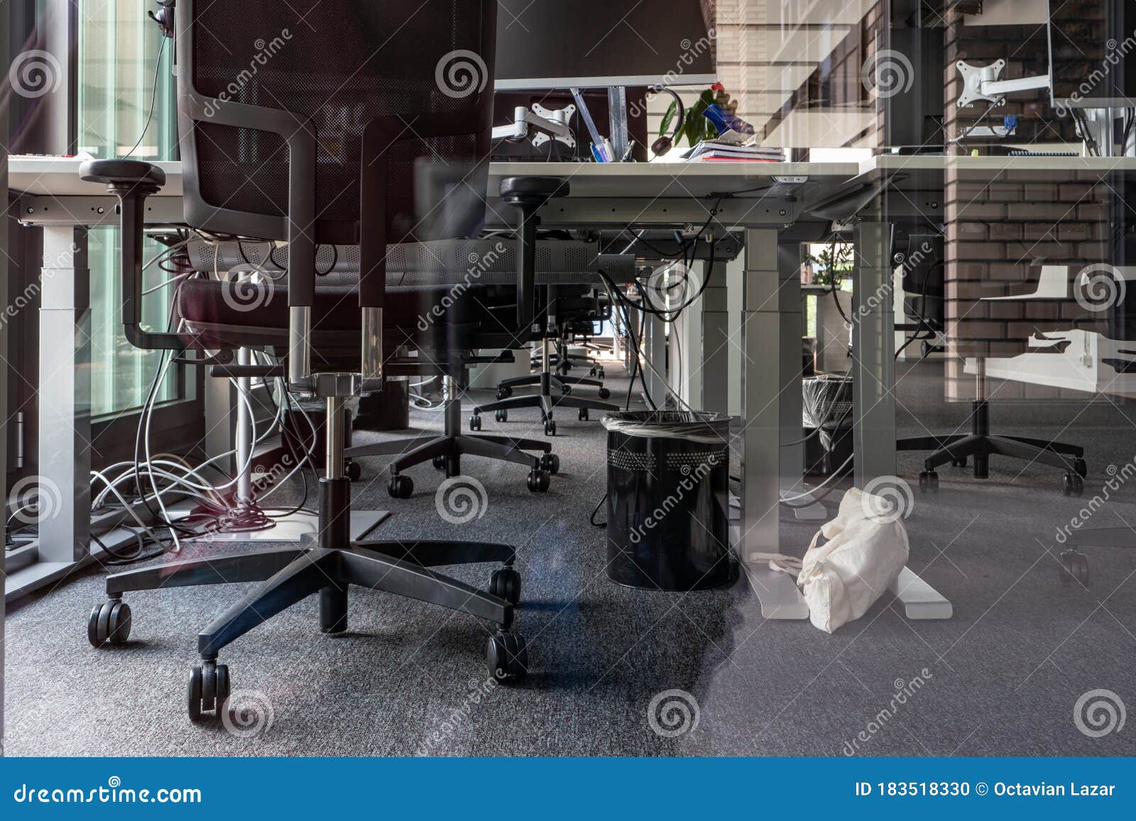 Empty Office Room with Multiple Work Desks Computers and Supplies Left ...