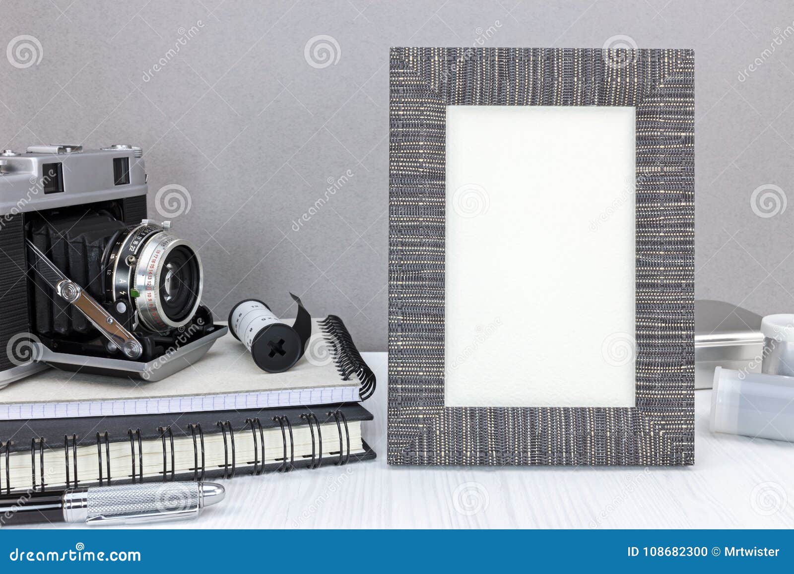 Empty Photo Frame and Vintage Camera on Grey Background Stock Photo ...