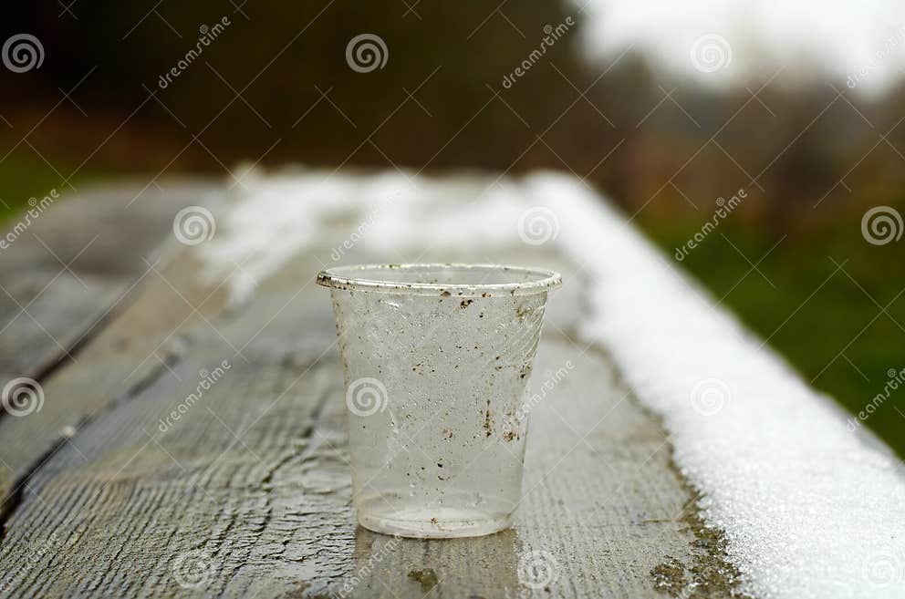 Empty plastic cup on bench stock image. Image of winter - 203710421