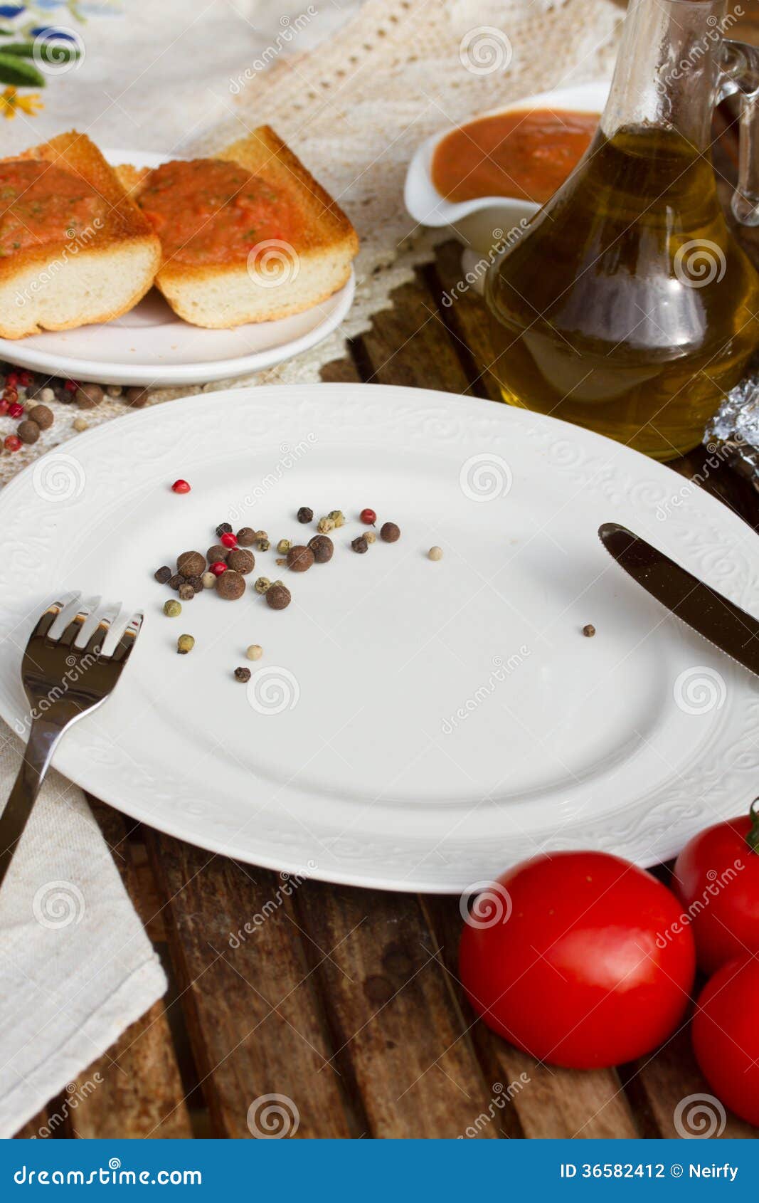 Empty Plate and Bread with Tomatoes and Olive Oil Stock Photo - Image ...