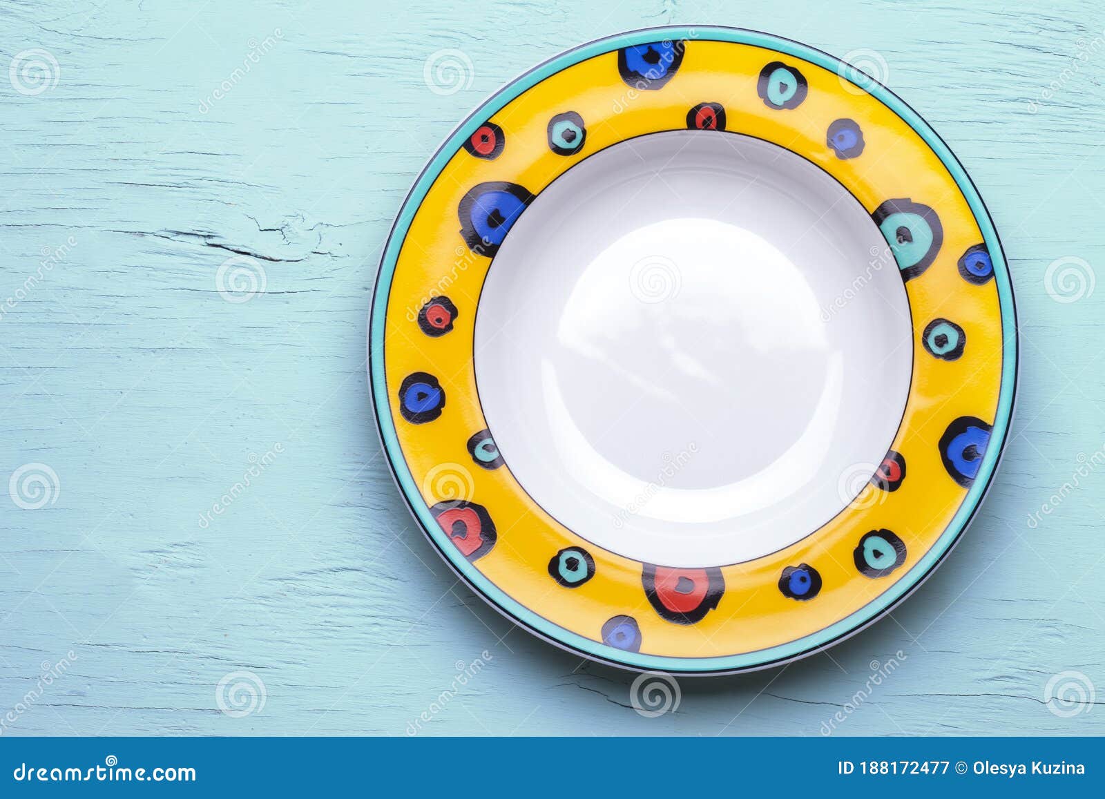 Empty Plate. Bright Multi-colored Plate. Isolated on a Blue Background ...