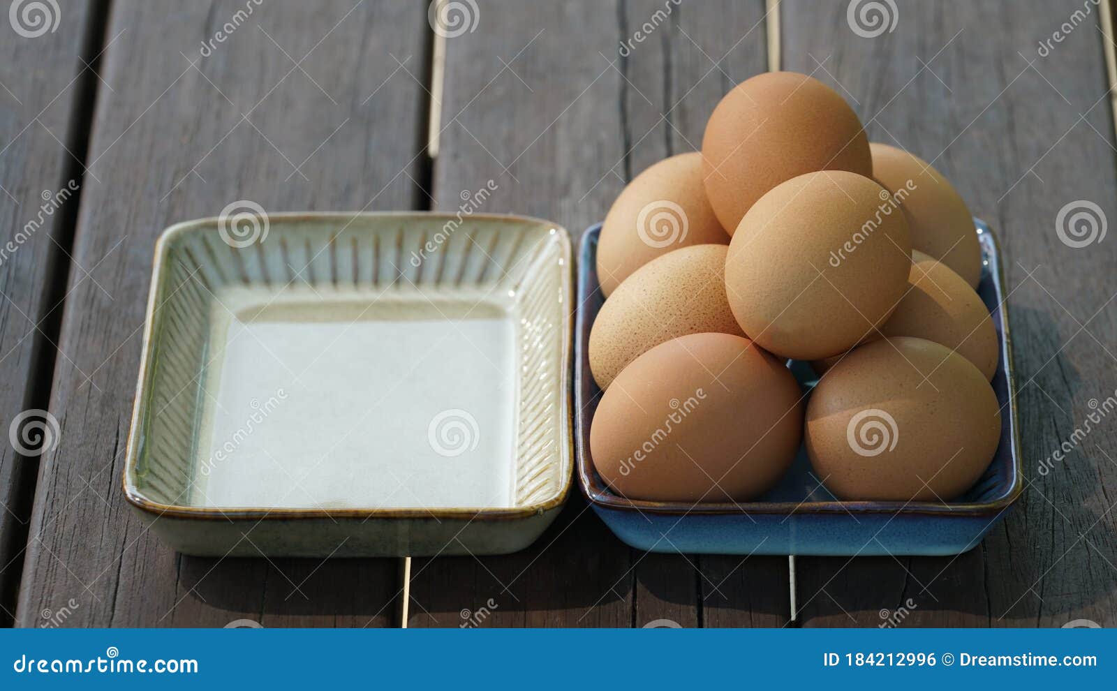An Empty Plate, and a Plate Full of Eggs on the Table Stock Photo ...