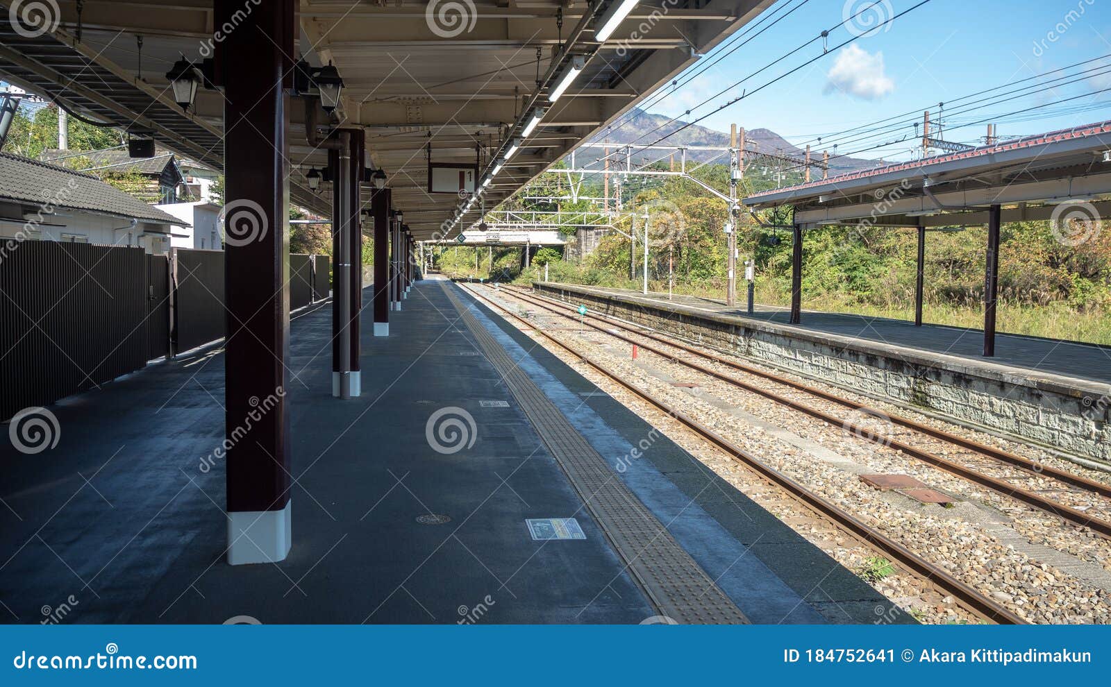 Empty Platform at Train Station with Metal Sheet Roof on Clear Blue Sky ...