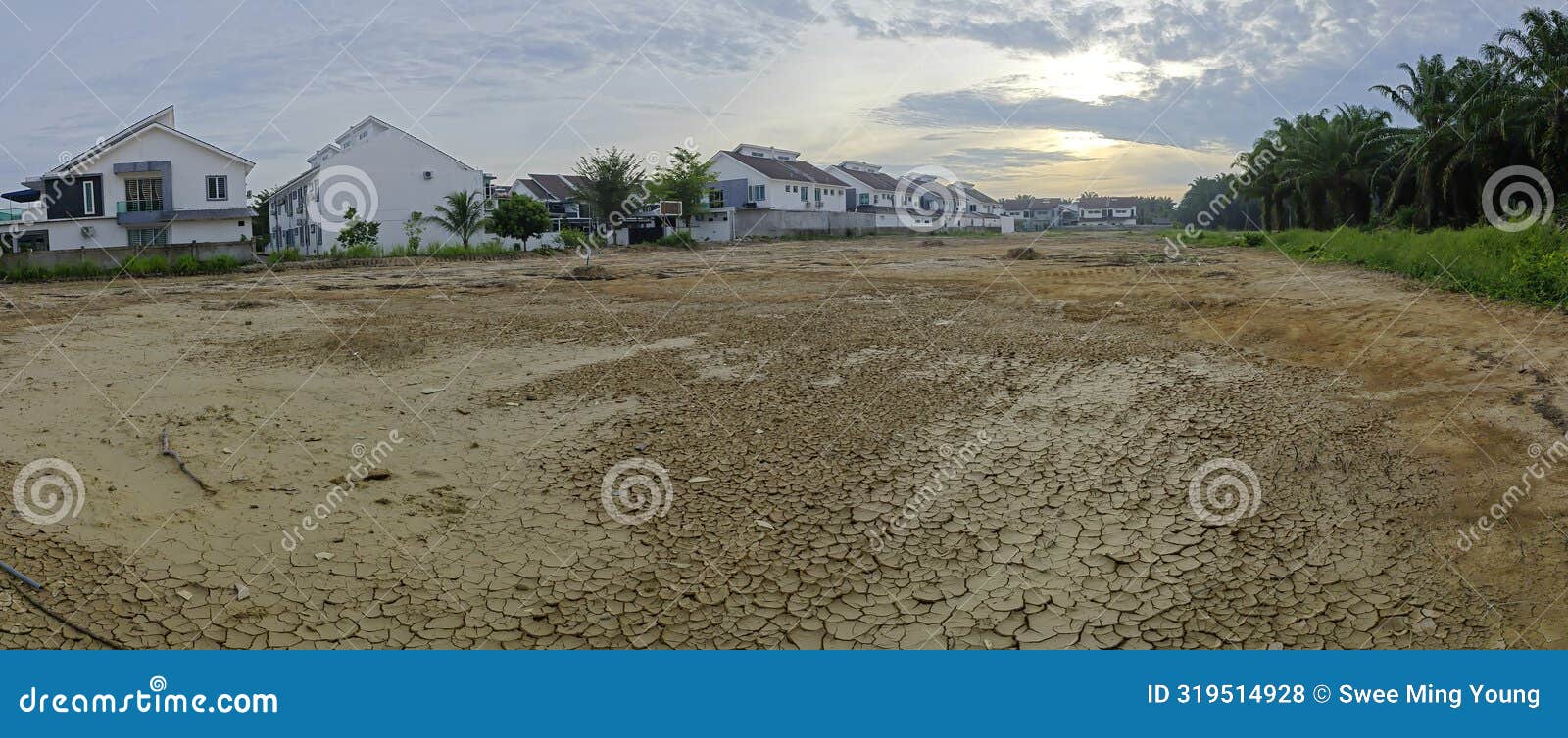 An Empty Plot of Land Scene Besides a Residential Row of Houses. Stock ...