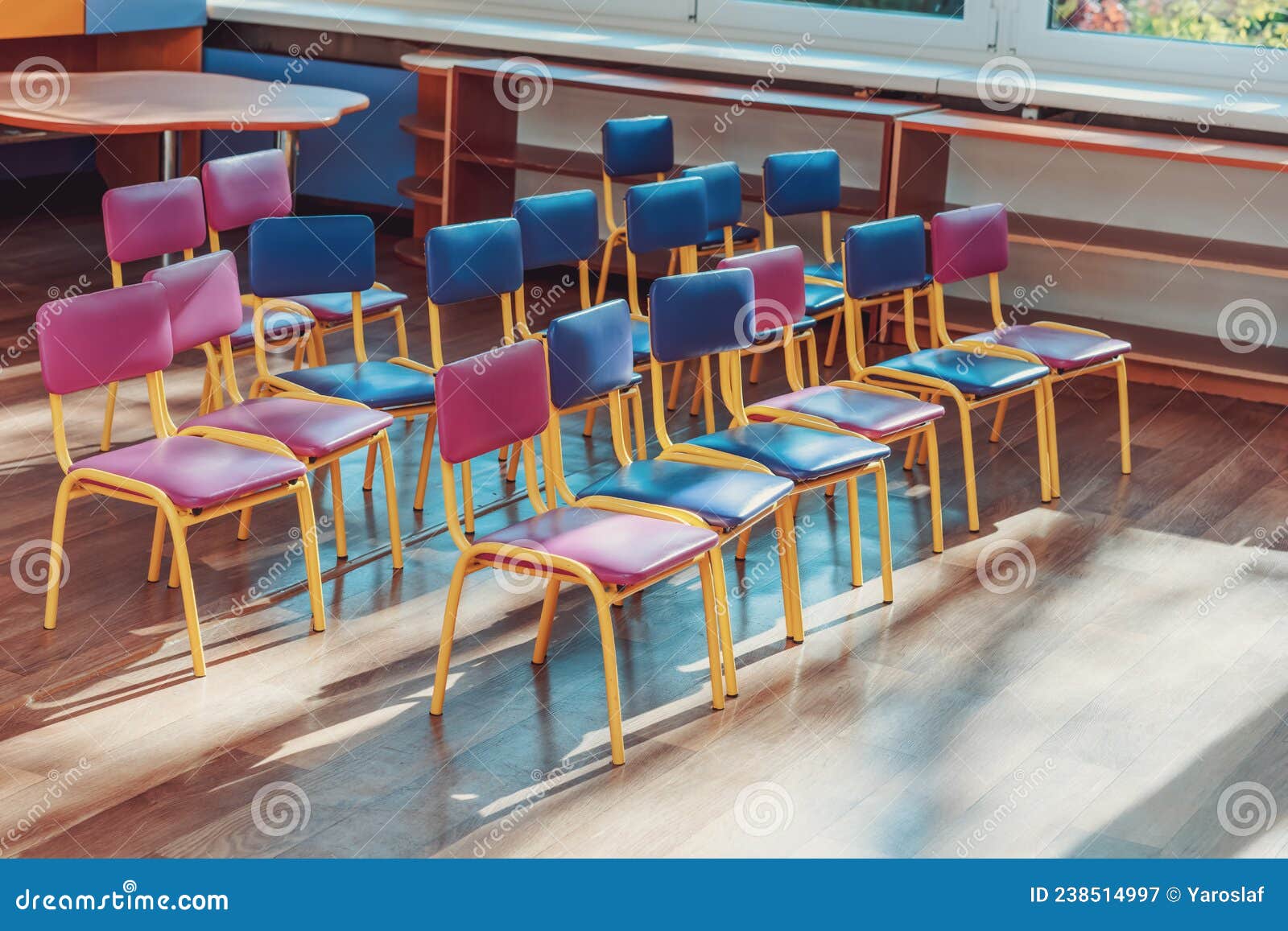 Empty Preschool Classroom with Multi Colored Chairs Standing in Rows ...