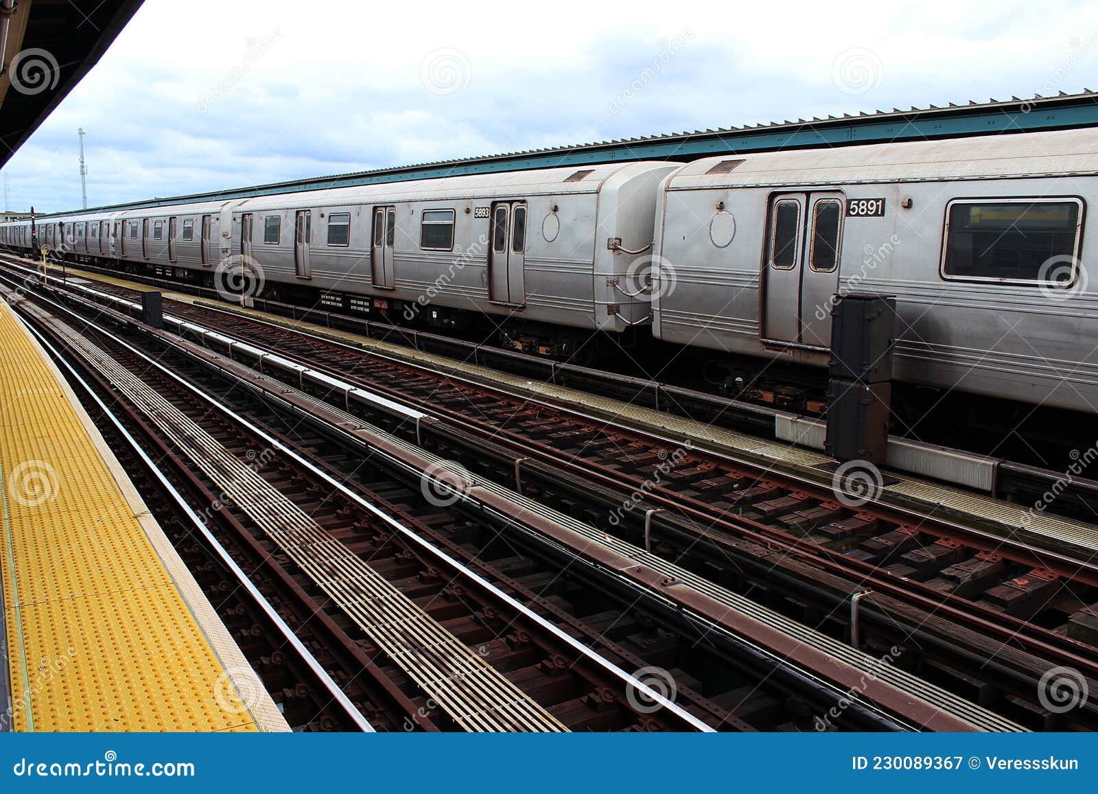 A Surface Metro Station With A Red Departing Train And A Two-level Car ...