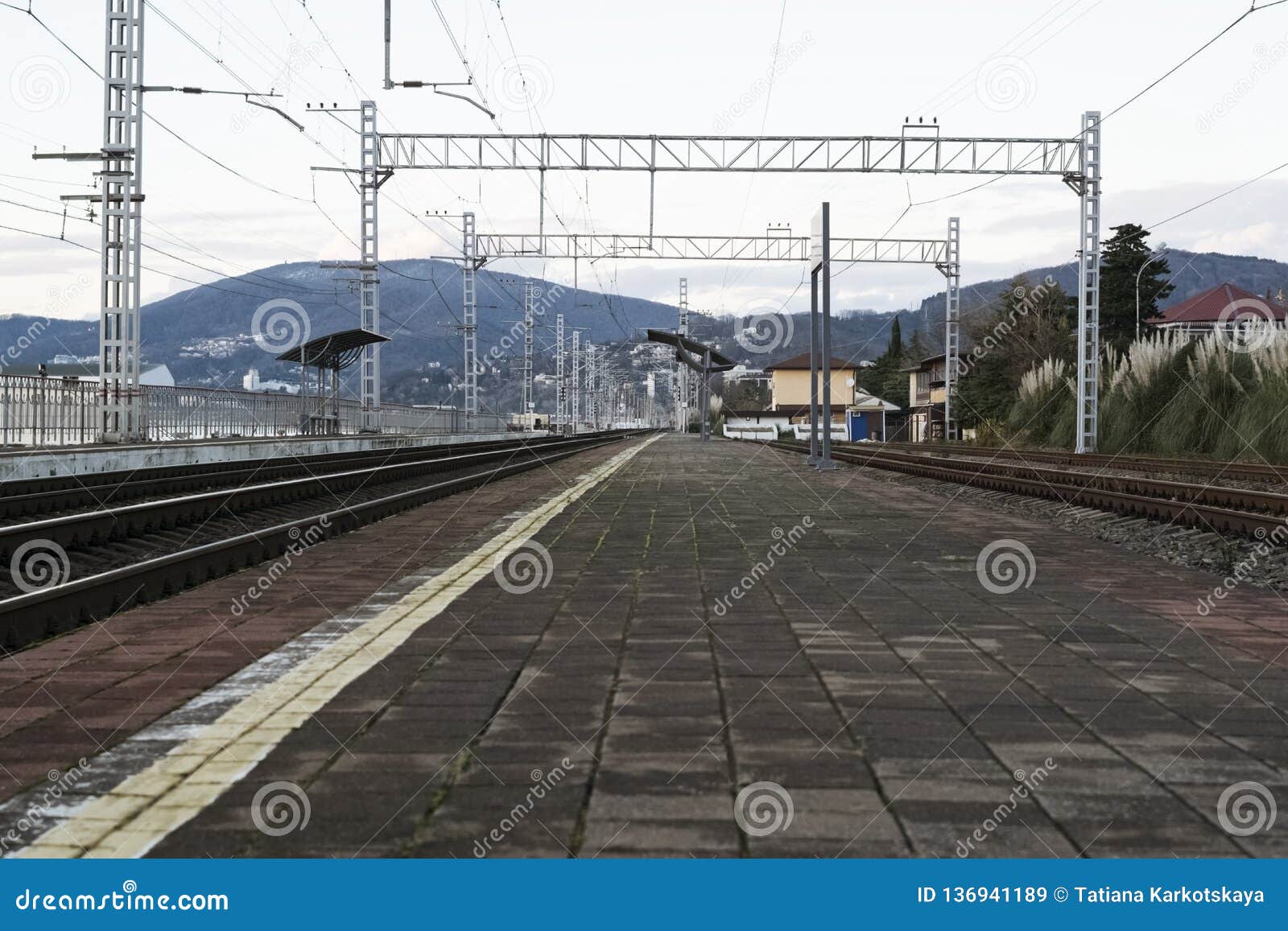 Empty Railway Station by the Sea Against the Mountain in the Evening ...
