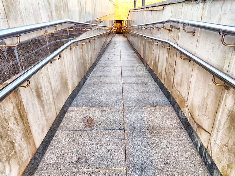An Empty Ramp Descends into an Underground Space, Illuminated by Soft ...