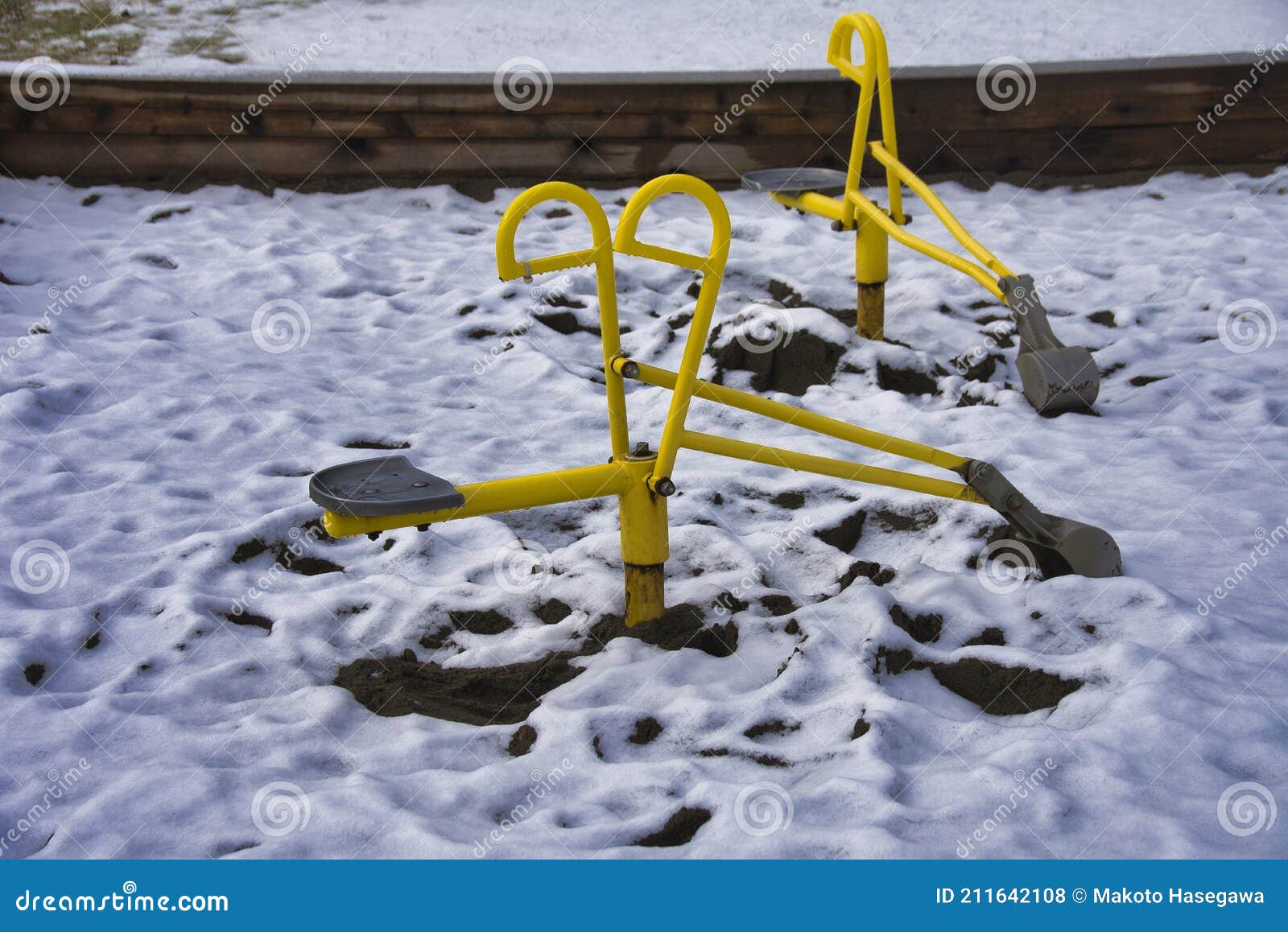 Empty Ride-on Sandbox Digger on Children`s Playground Under the Snow ...