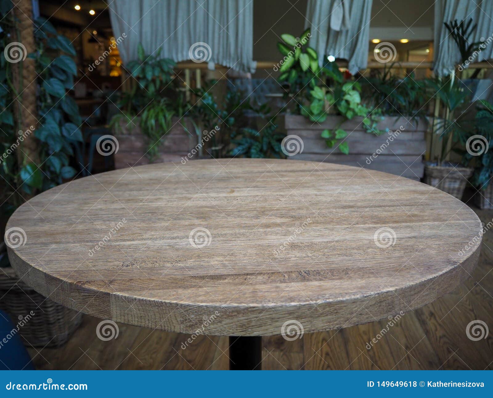 Empty Round Wooden Table in a Restaurant on the Background of Green ...