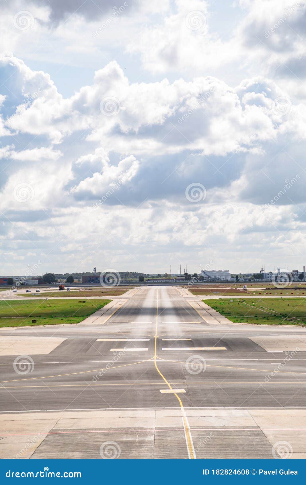 Empty Runway for Planes with Loaders in Distance Stock Photo - Image of ...
