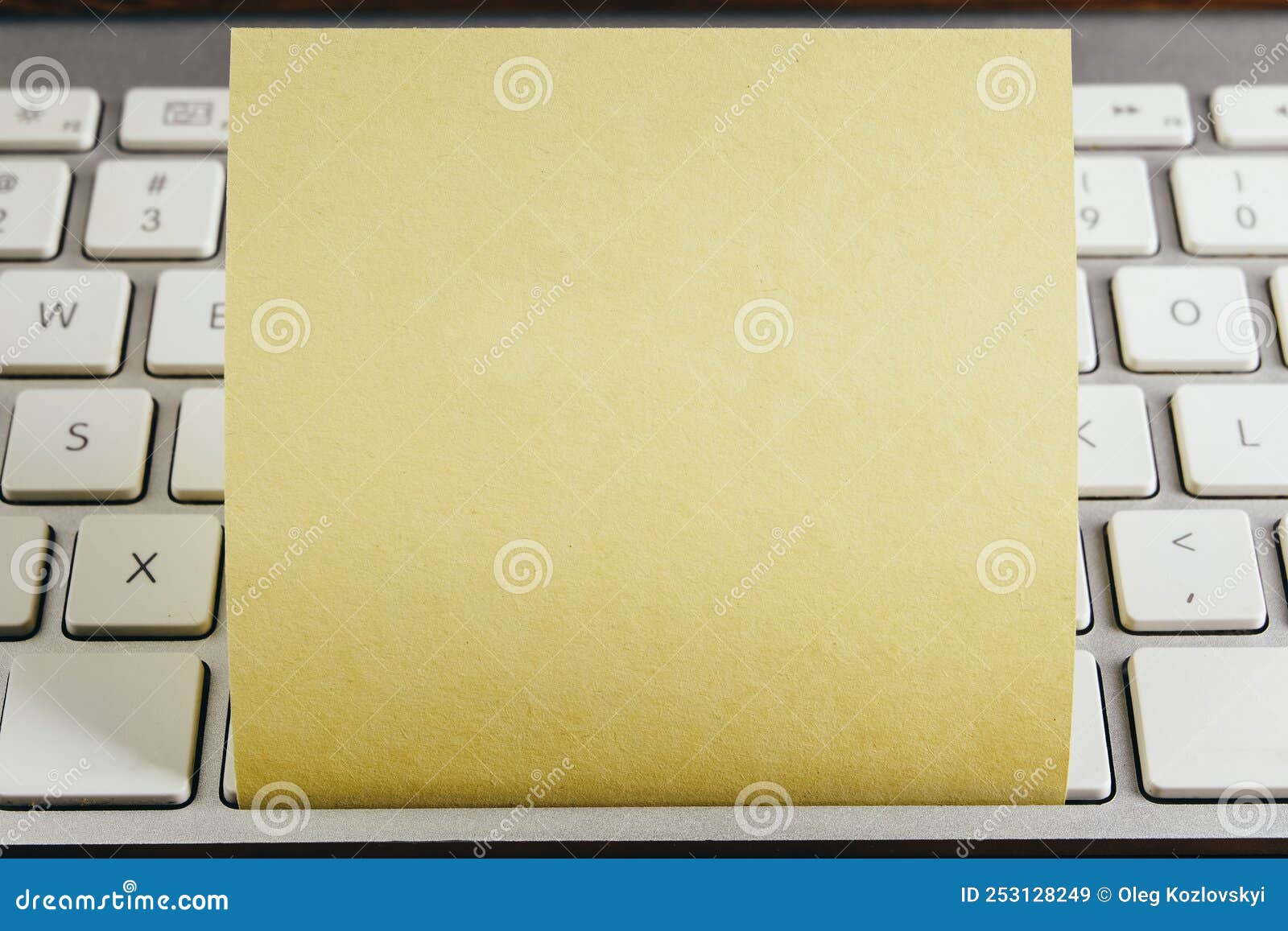 An Empty Sheet of Yellow Paper Stuck into the Keyboard. Close-up Stock ...