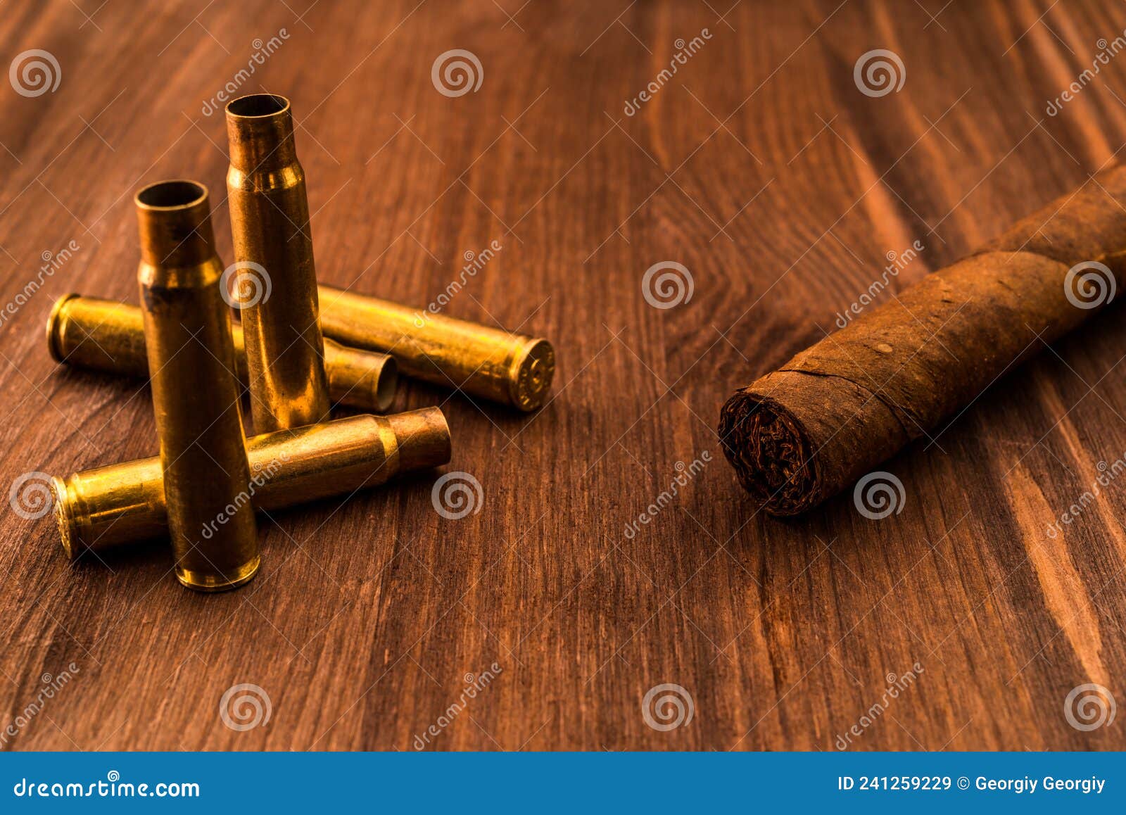 Empty Shells from the Rifle and Cuban Cigar Lying on a Wooden Table ...