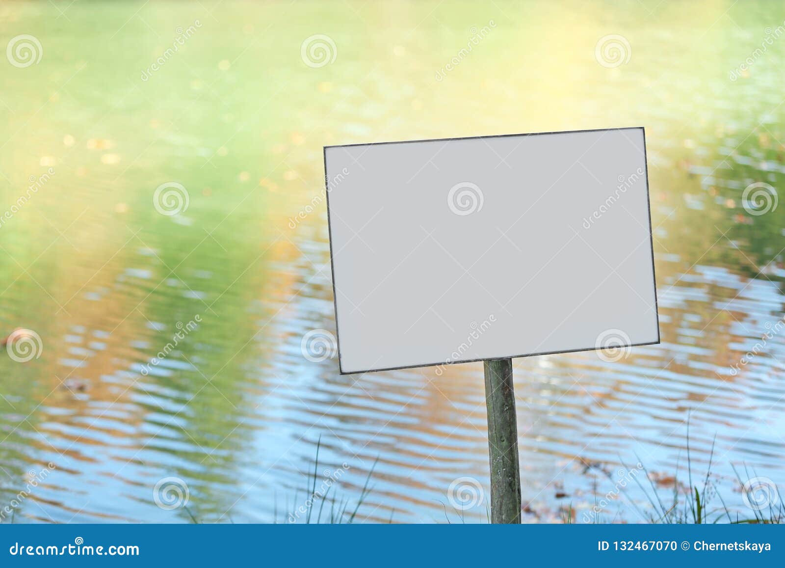 Empty sign board near pond stock photo. Image of message - 132467070