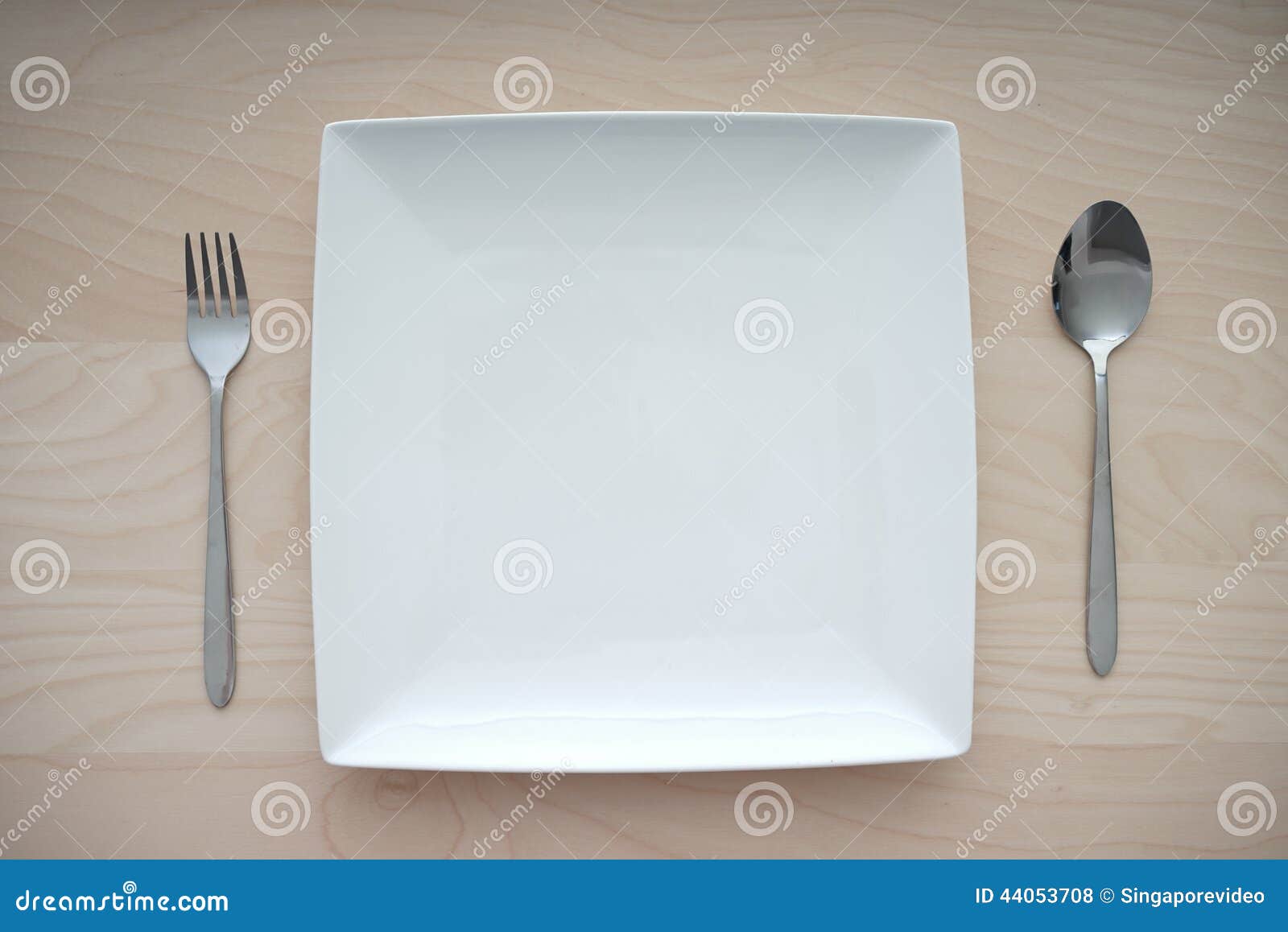 Empty Square Plate on Wooden Table with Fork and Spoon Stock Photo ...