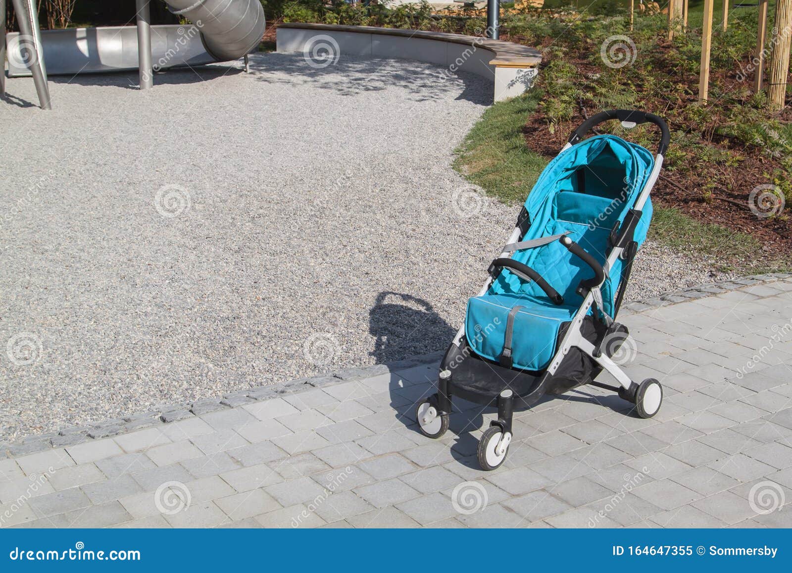 Empty Stroller Stands Near Modern Playground with Large Metal Slide ...