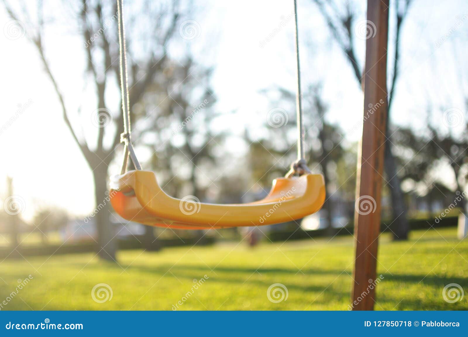 Empty swing in the park stock photo. Image of playground - 127850718