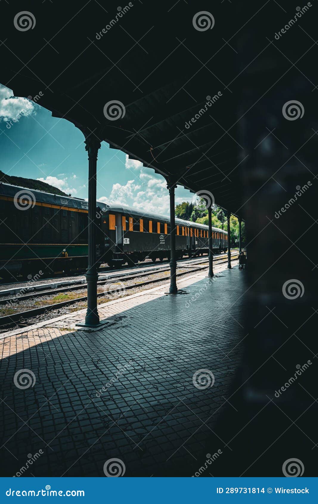 Empty Train Station Illuminated in the Evening Light As a Train Passes ...