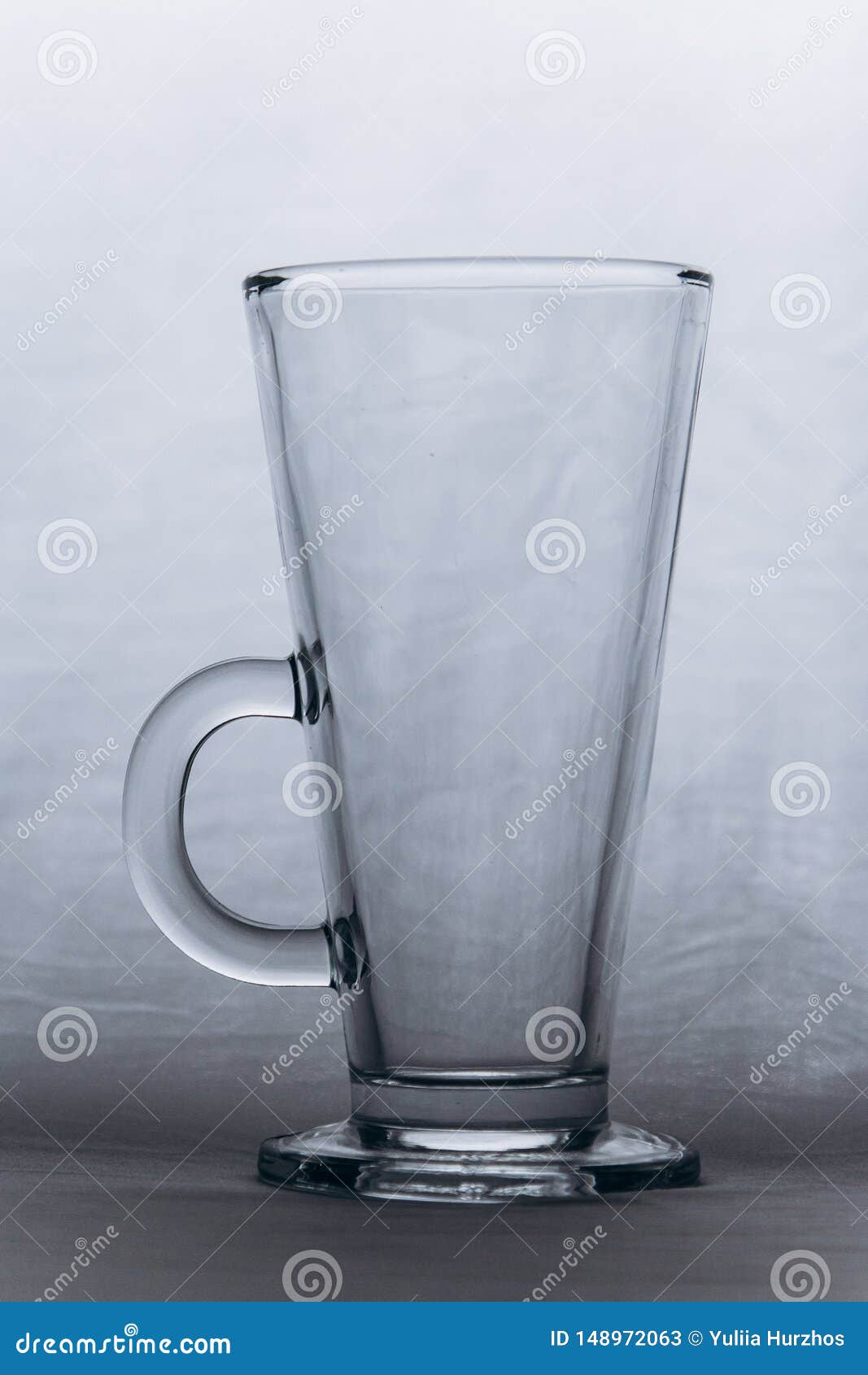 Empty Transparent Glass Cup on a Gray Silver Background Close-up. High ...