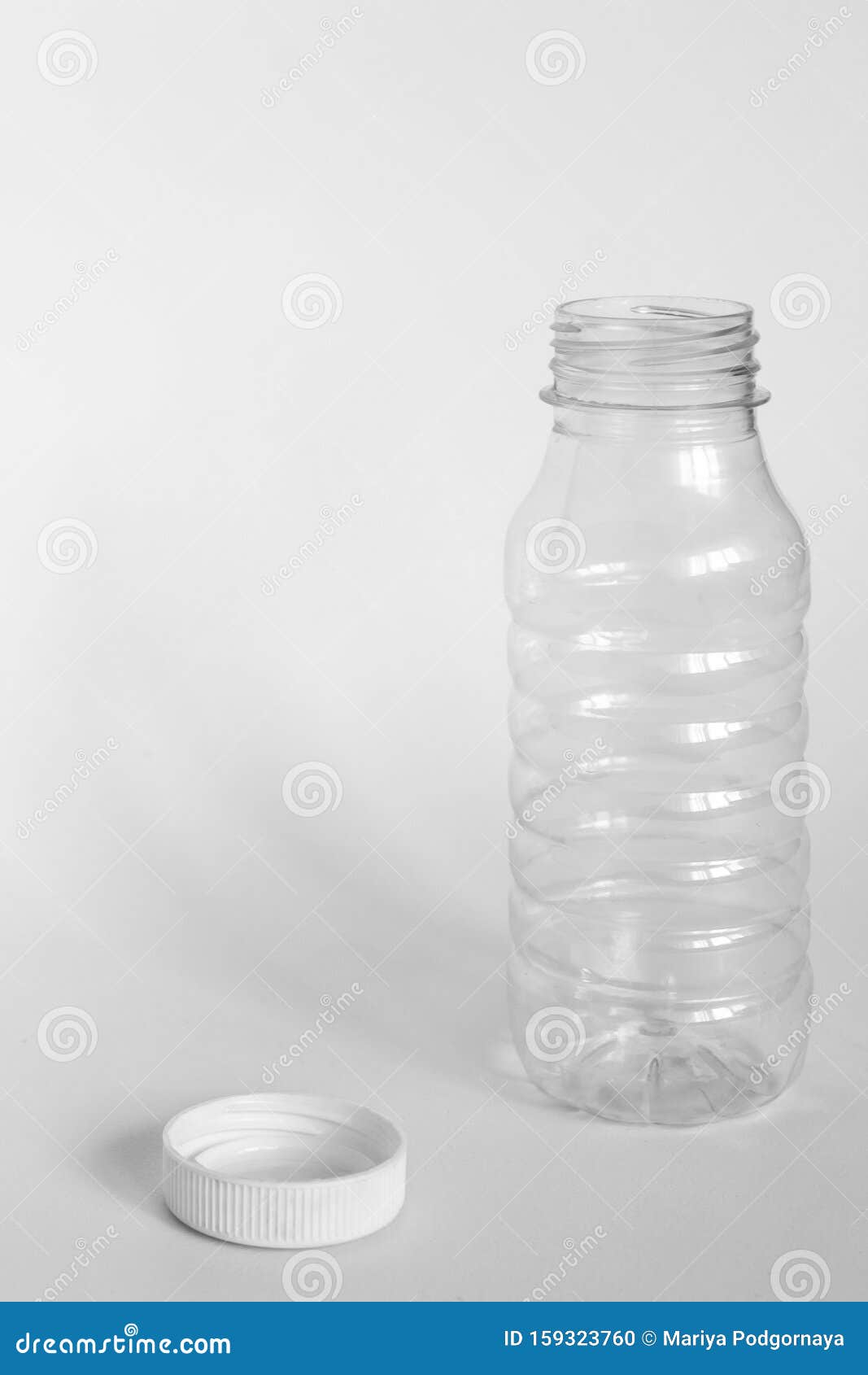 Empty Transparent Open Plastic Bottle without Cap, Cap Lies Next To a ...