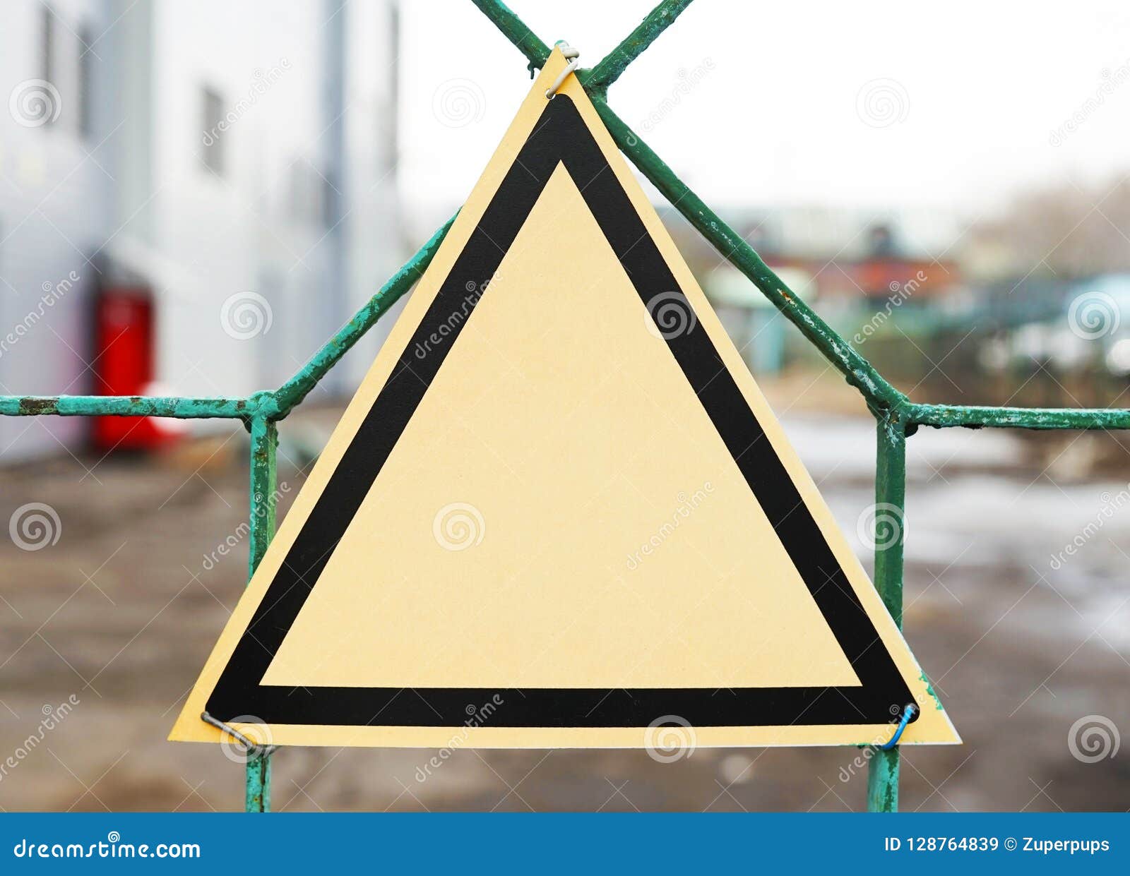 A Triangular Warning Sign With Flashing Lights Stands In Front Of A ...
