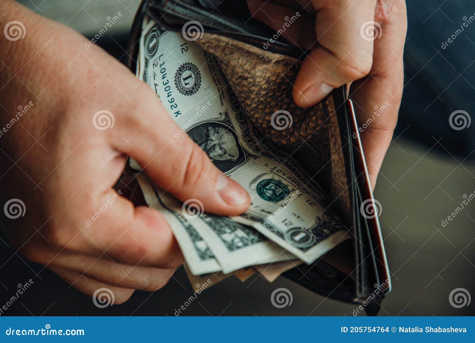 An Empty Wallet with a Small Amount of Money in the Hands of a Working ...