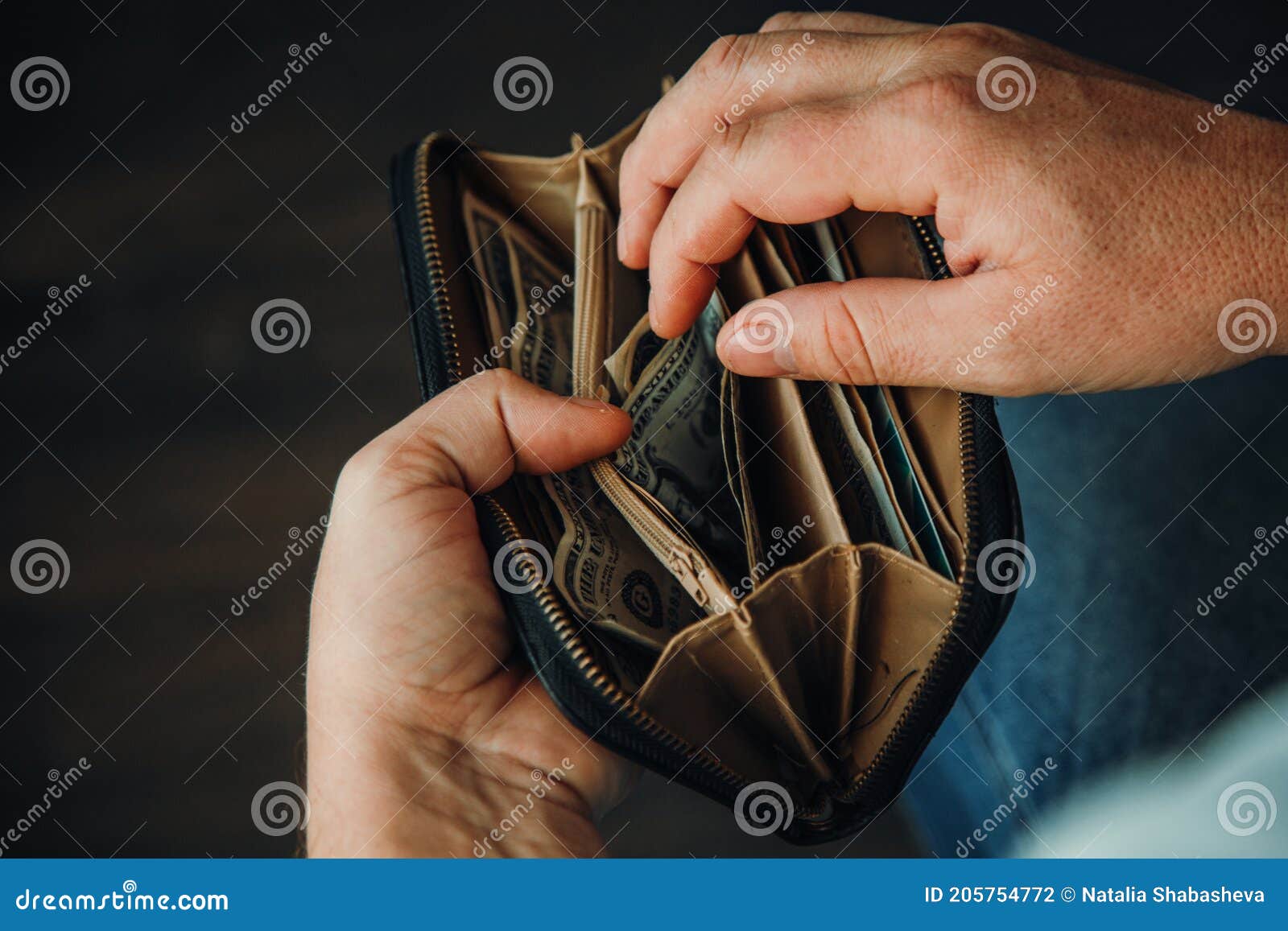 An Empty Wallet with a Small Amount of Money in the Hands of a Working ...