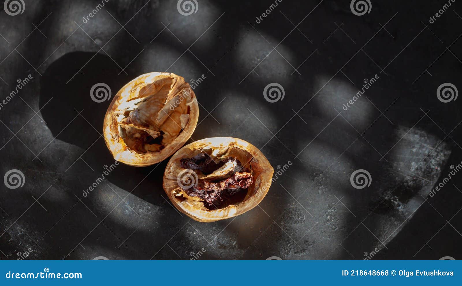 An Empty Walnut Shell with a Dried Walnut Kernel on a Black Background ...