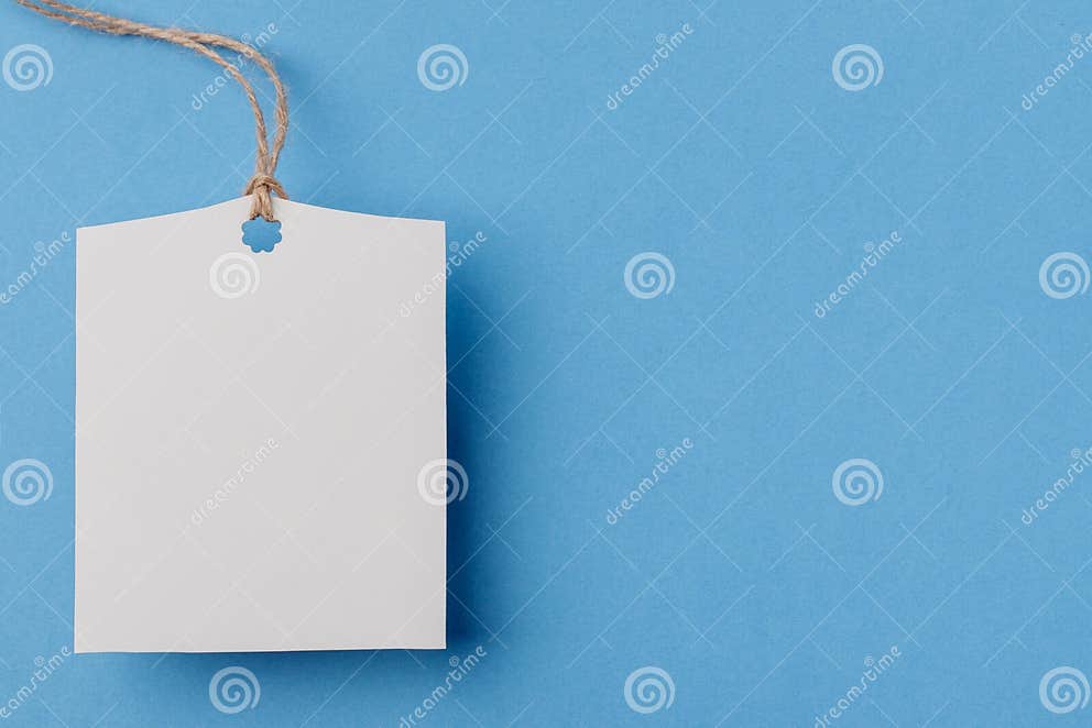 Empty White Rectangular Paper Tag on a Rope on Blue Background Stock ...