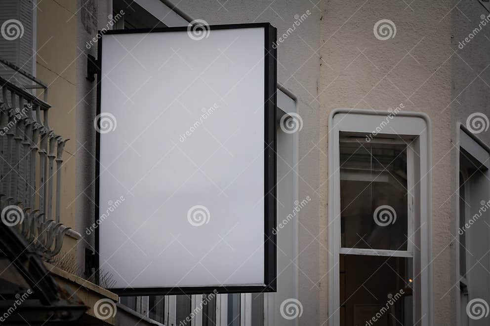 An Empty White Rectangular Sign Hangs Outside a German Store, Offering ...