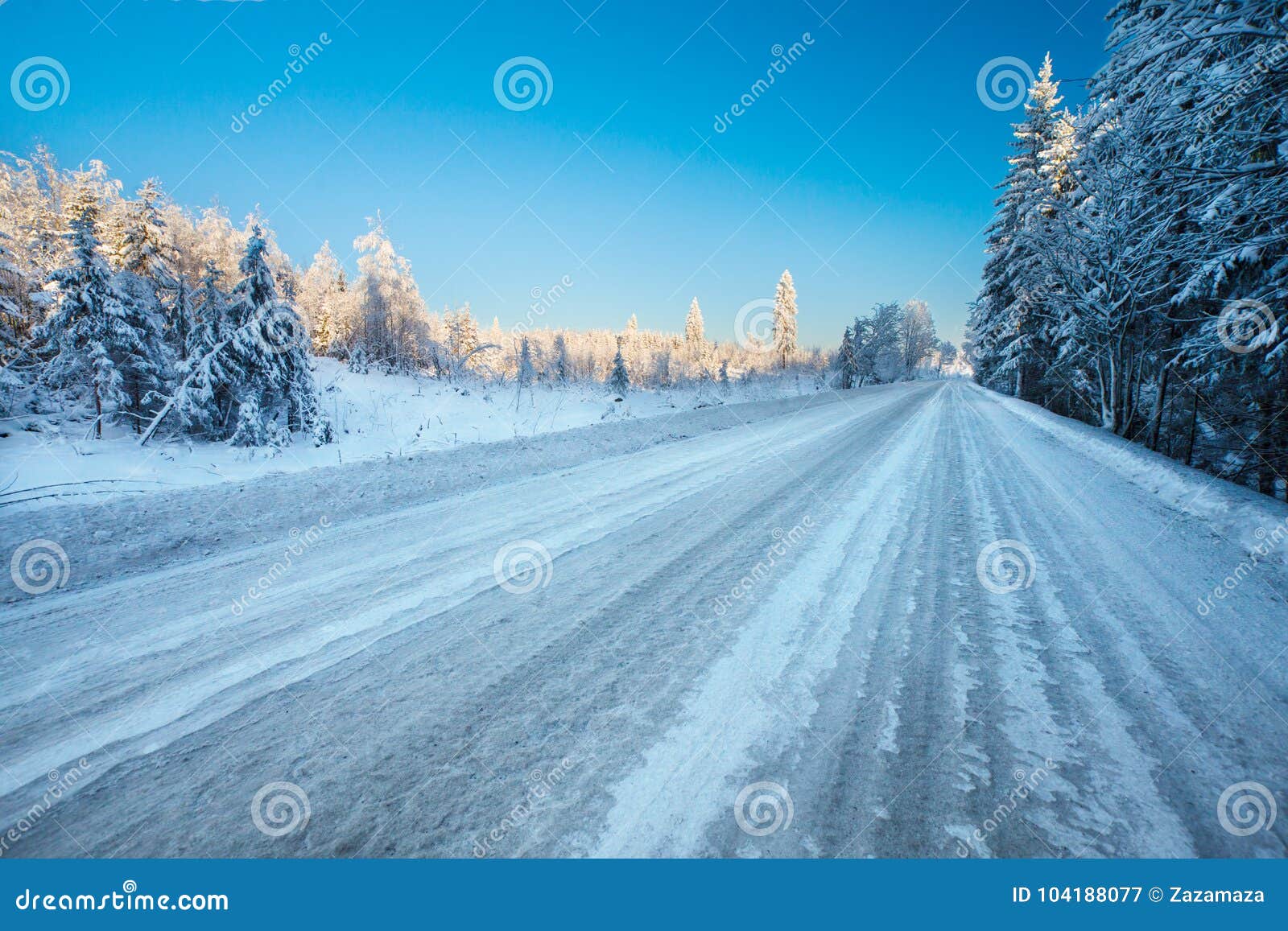 Empty Winter Road with Ice-slick and Snow through Snowy Fields and ...