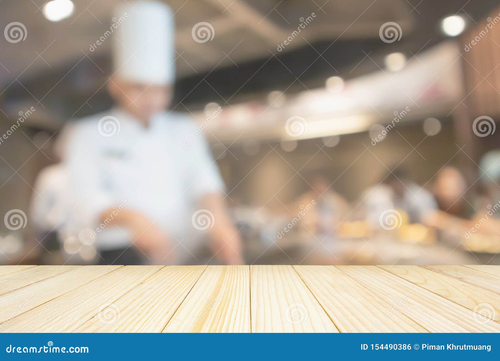 Empty Wood Table Top with Chef Cooking in Restaurant Kitchen Blurred ...
