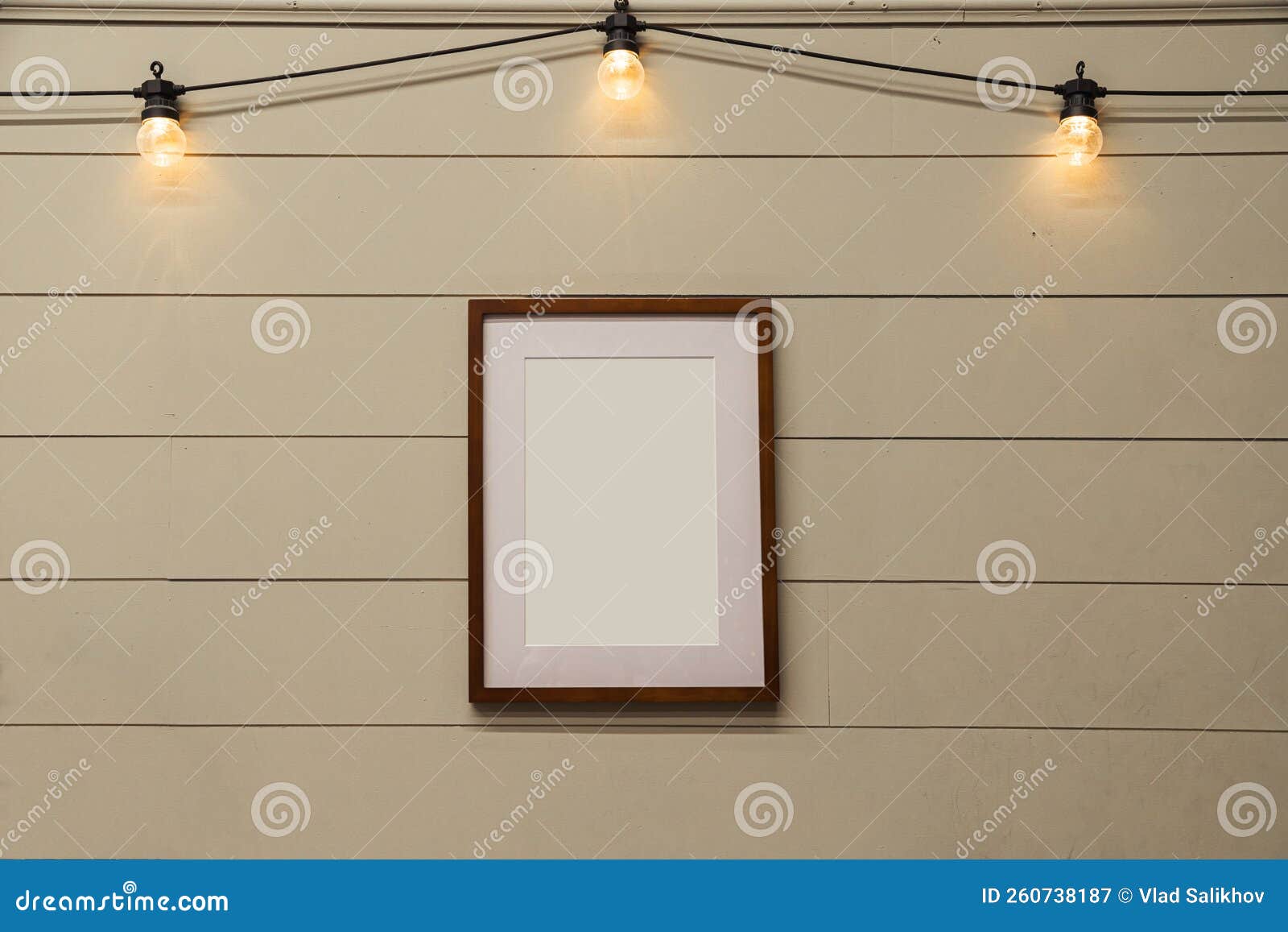 Empty Wooden Frame on Wooden Wall with Garland and Light Bulbs on Top ...
