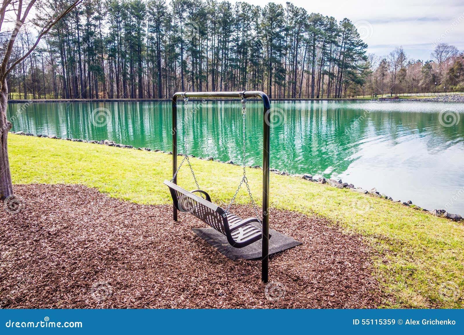 Empty Wooden Park Bench Overlooking a Lake or Pond Stock Image - Image ...
