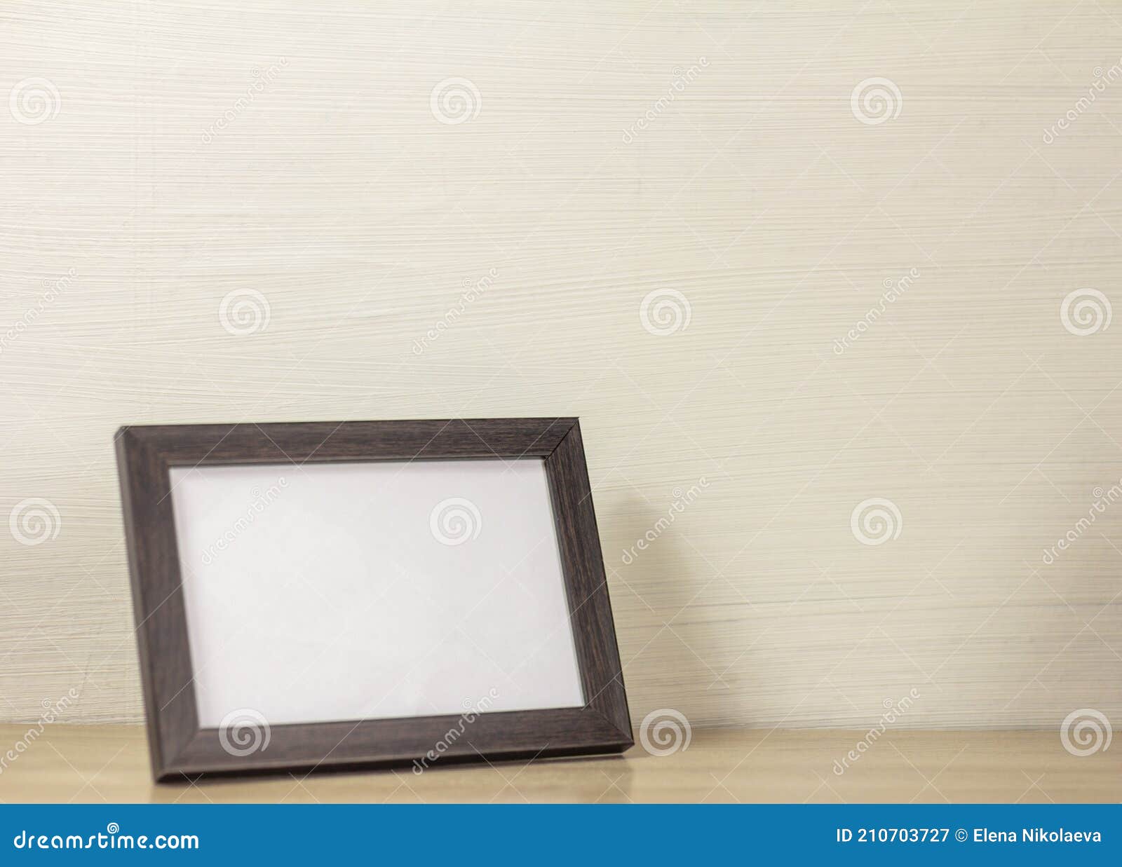 An Empty Wooden Photo Frame on a Table or Shelf with a Copy of the ...
