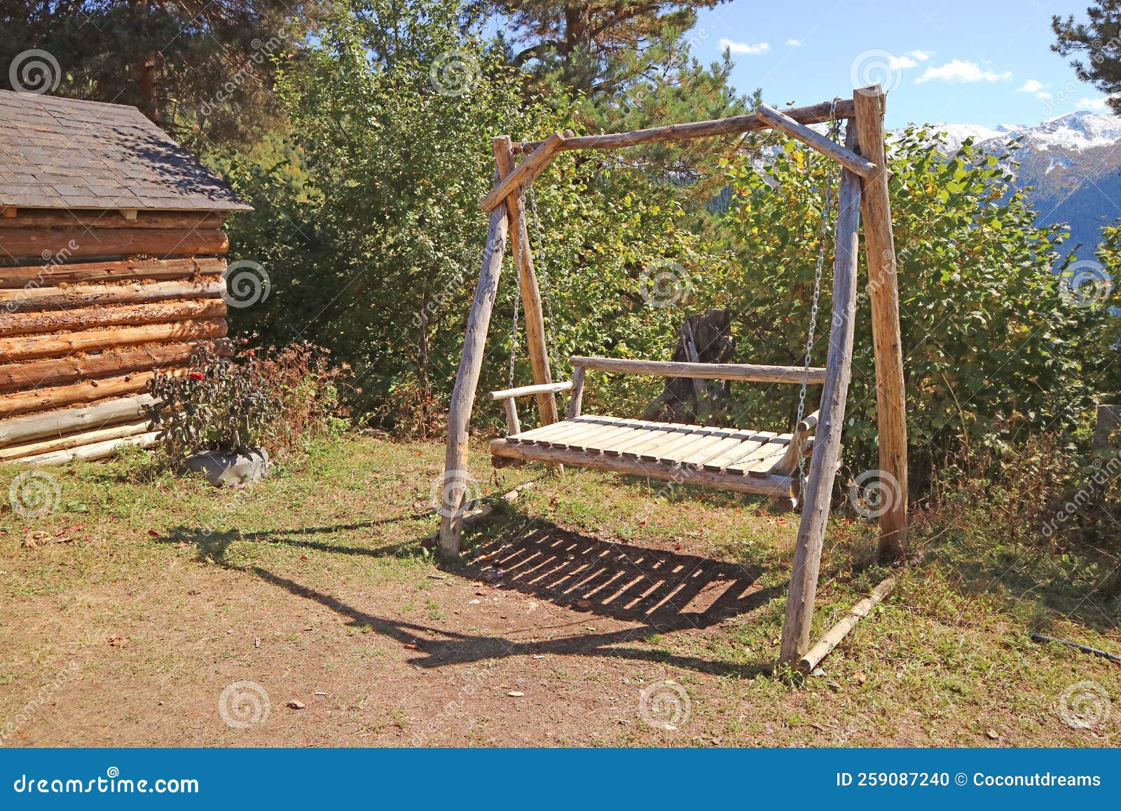 Empty Wooden Swing beside Log Cabin Stock Photo - Image of grass ...