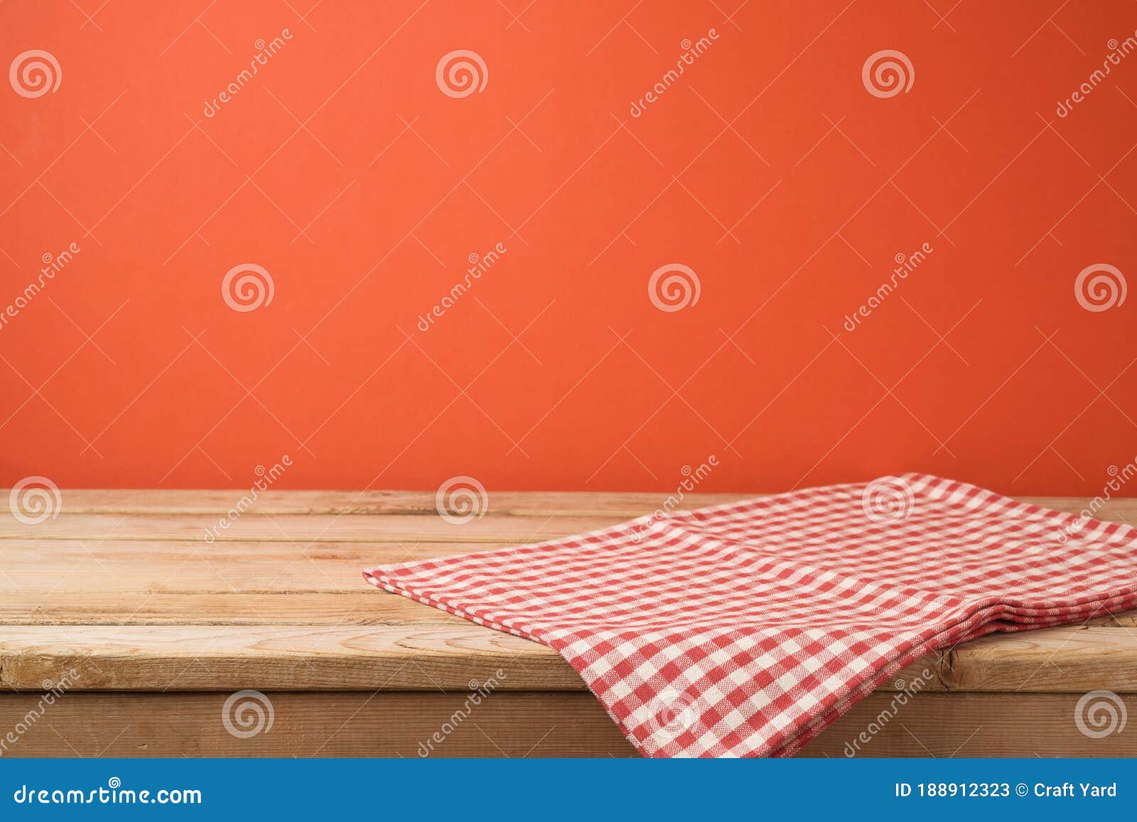 Empty Wooden Table with Red Checked Tablecloth Over Red Wall Background ...